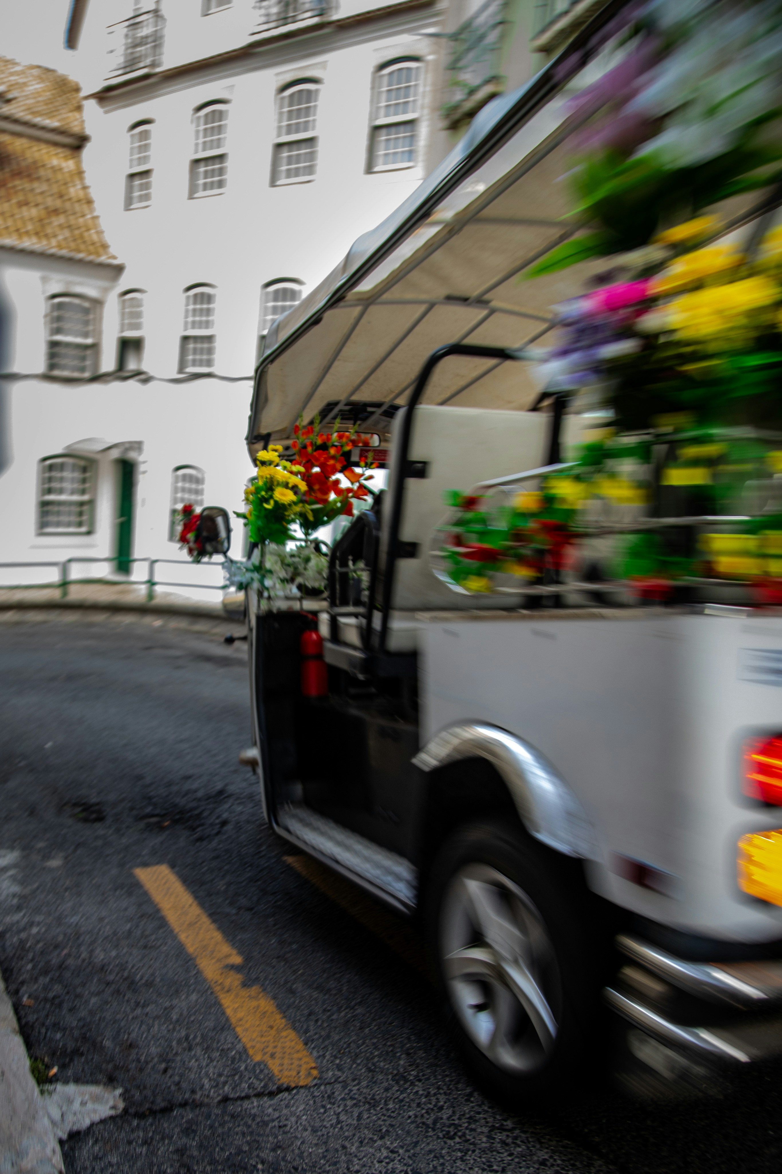 Flower-filled Delivery: A Blurred Street-truck Moment