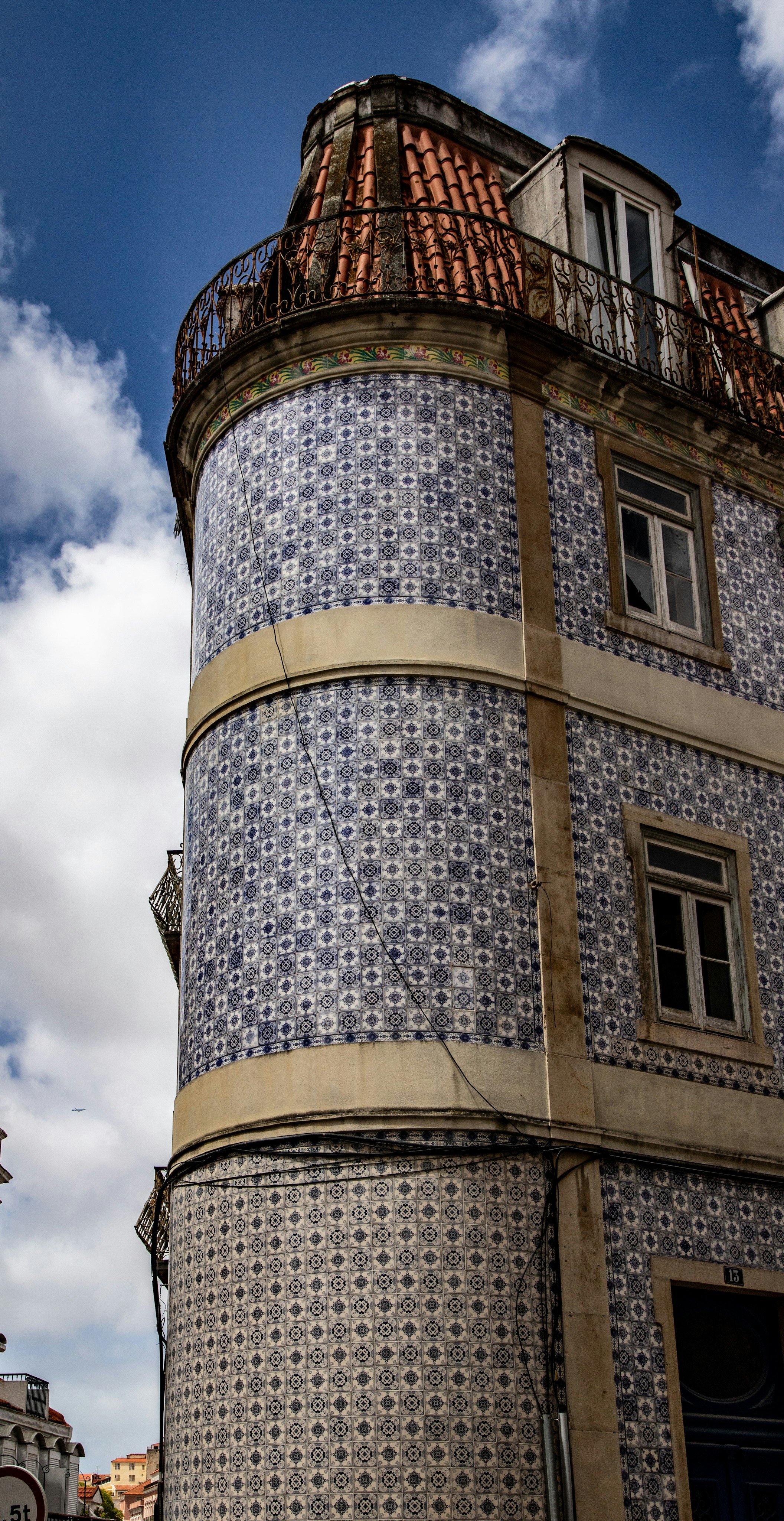 Azulejo Tower: fortune of tiled curves under a blue sky