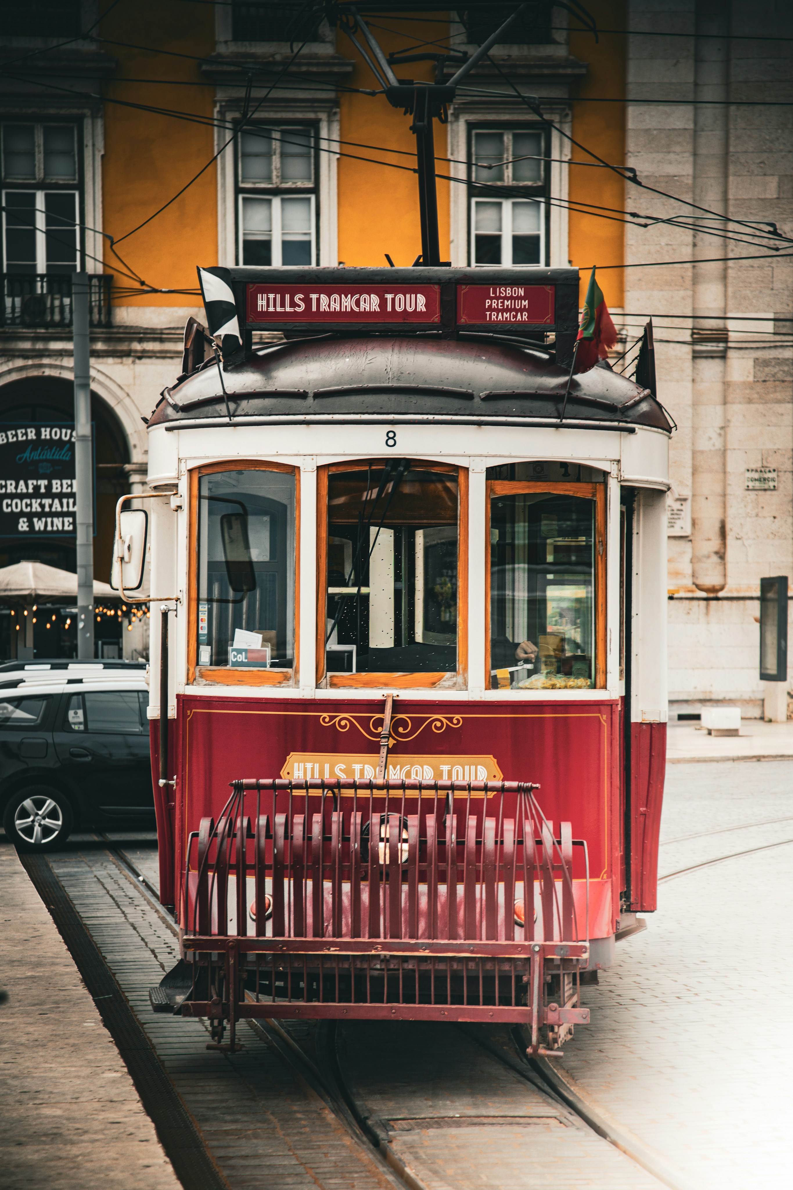 Yellow-and-red Tramcar on a Curved City Track in Lisbon