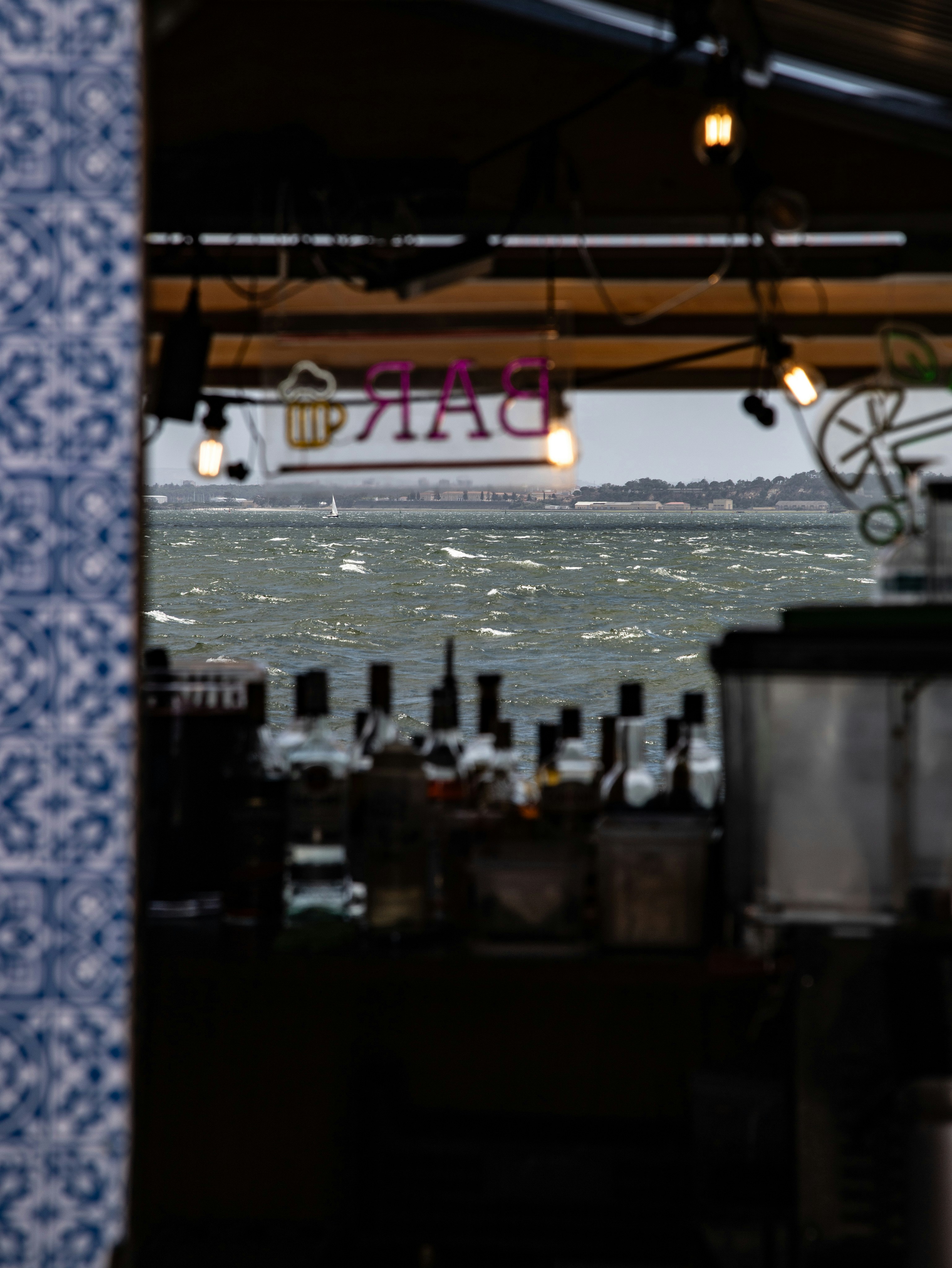 Harbor Window: Sunset Prefab and Rippled Sea Through a Coastal Café
