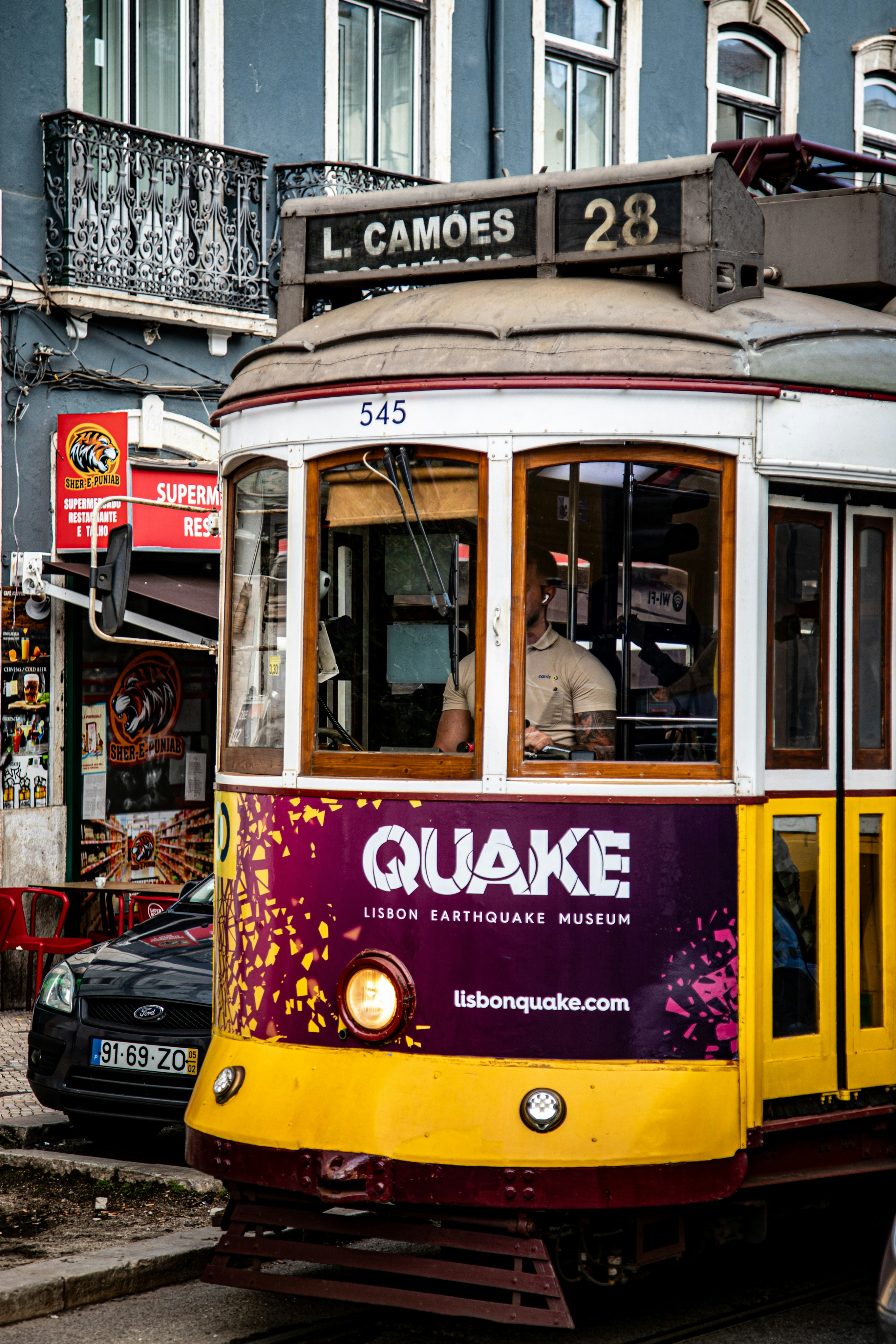 Electric Ride: A Vintage Tram Carves Through Lisbon’s Street Scene