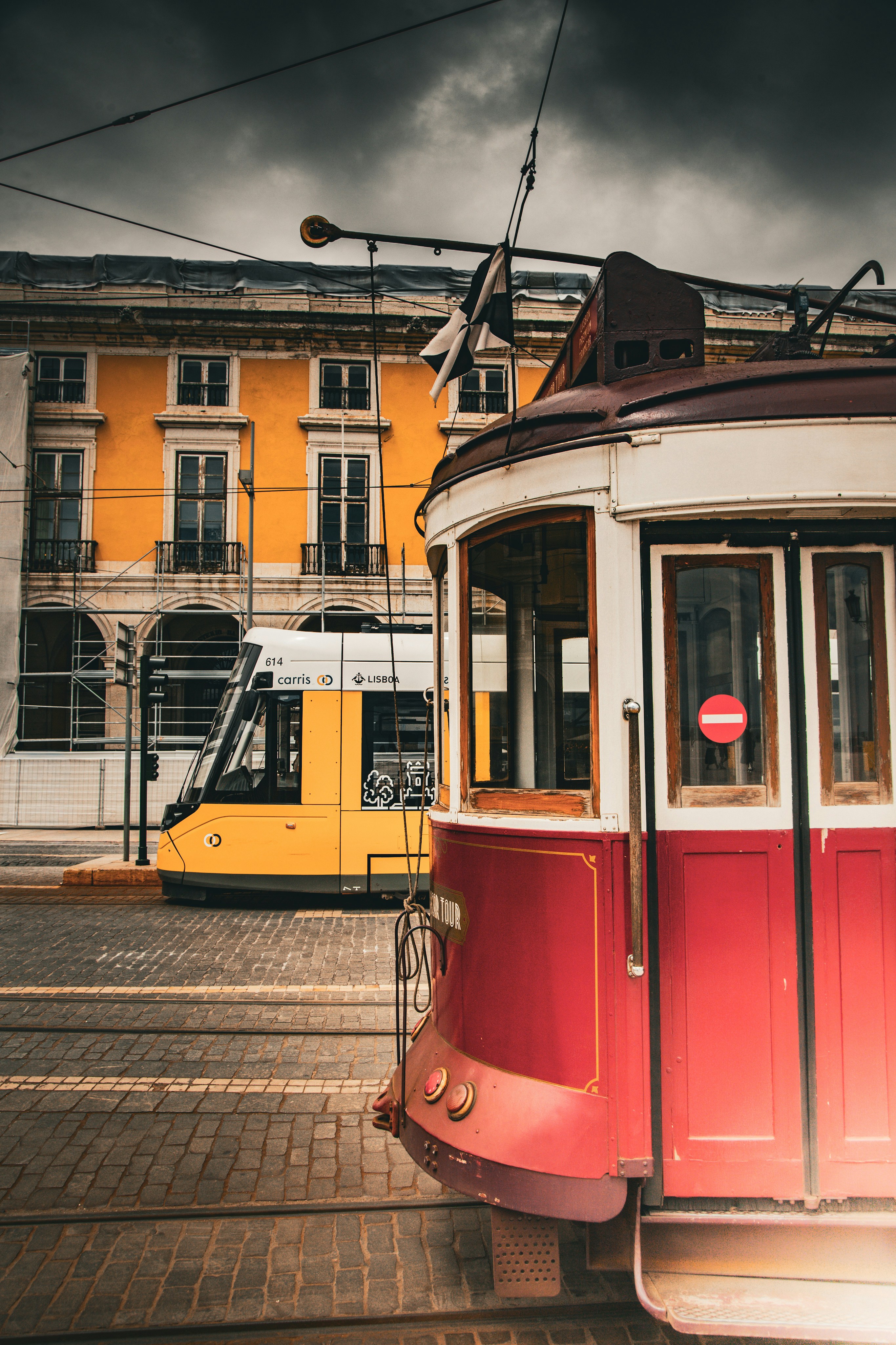 A City Tram Tango: Red Carriage in the Shadow of Yellow Facades