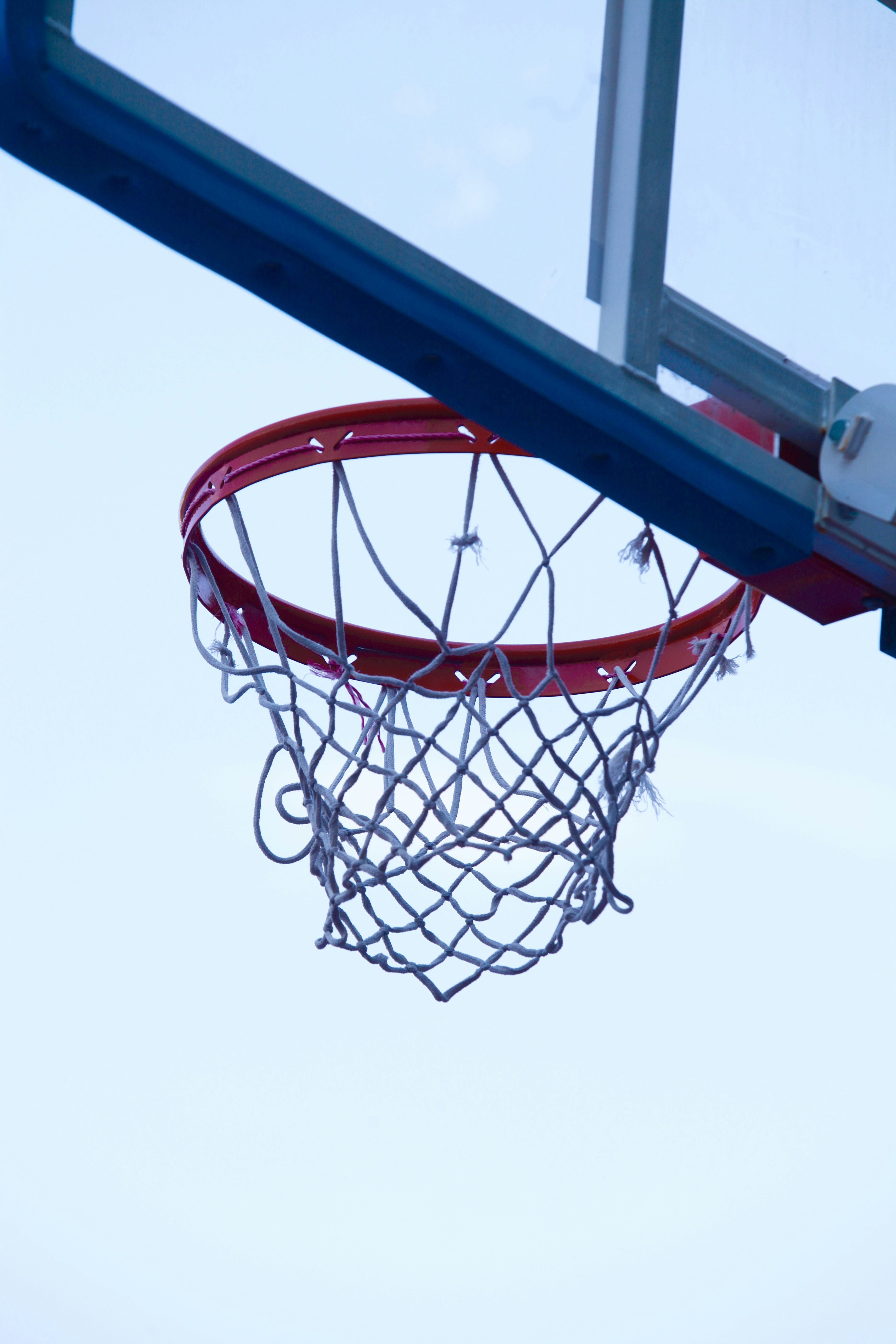 Hoop of Quiet Skies: A Basketball Hoop Against a Clear Blue Moment