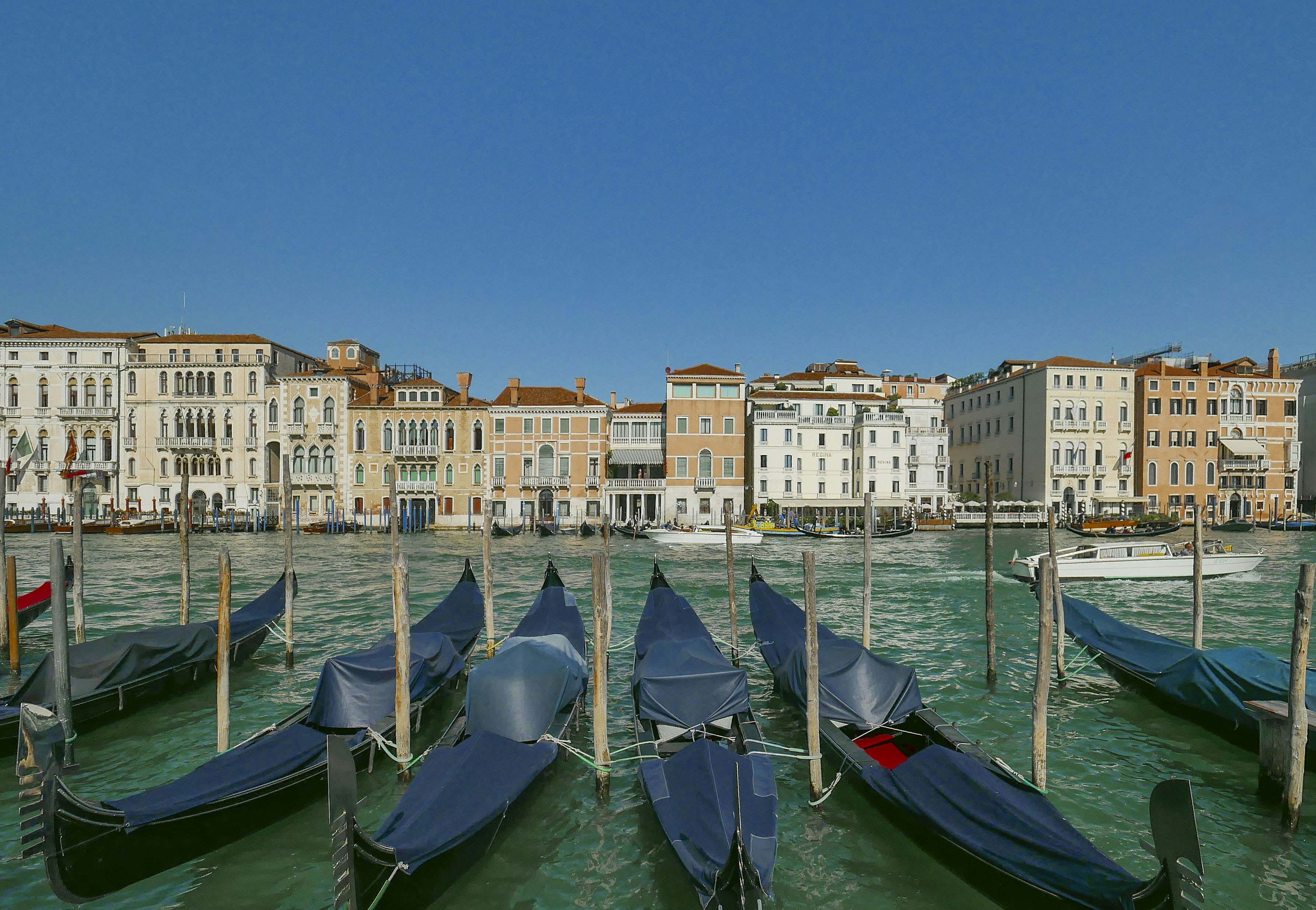 Row of Venetian Vessels: A Sunset Panorama of Boats and Historic Waterfront