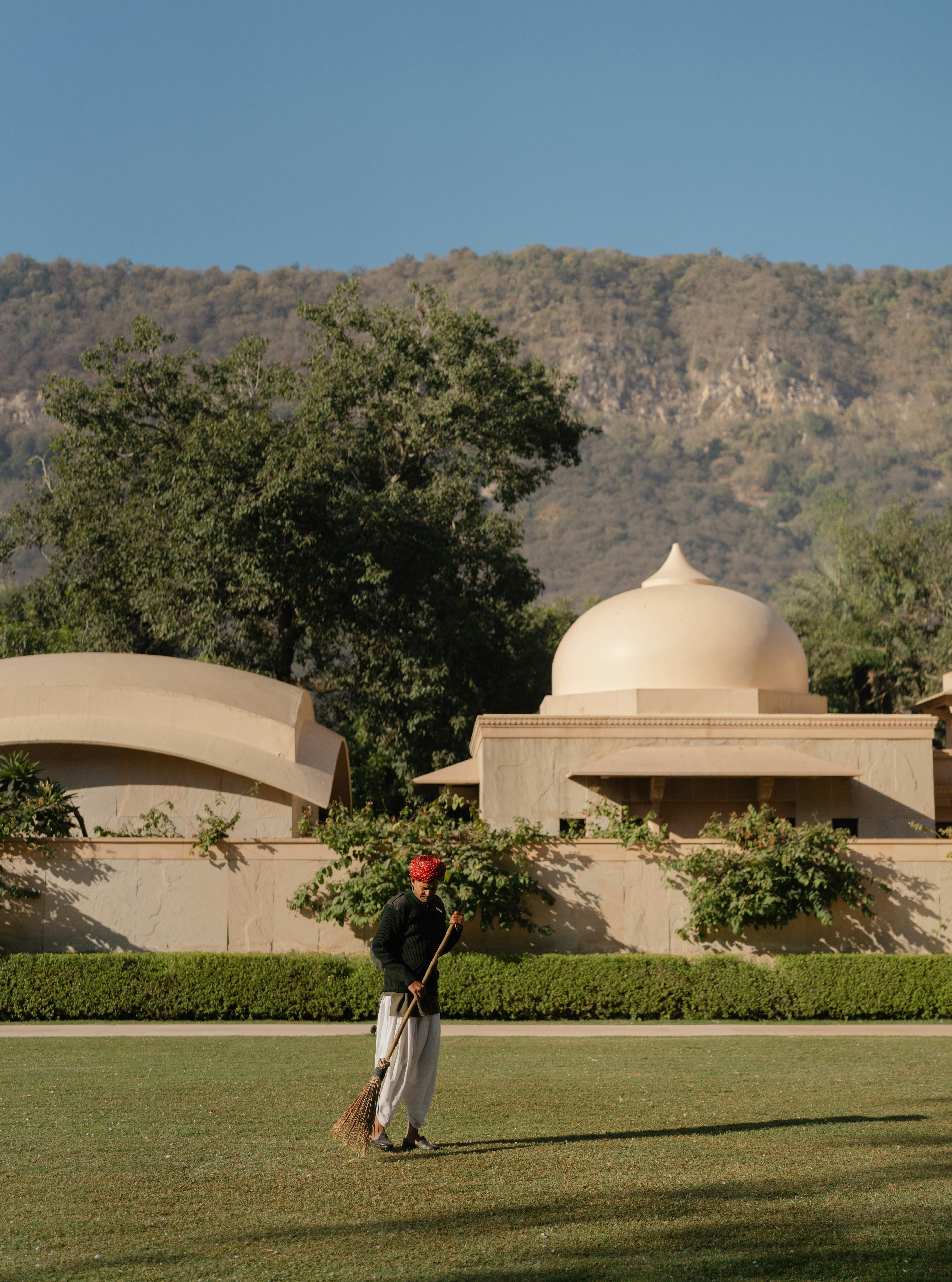 Sweeping Groundskeeper at a Desert Architecture Campus