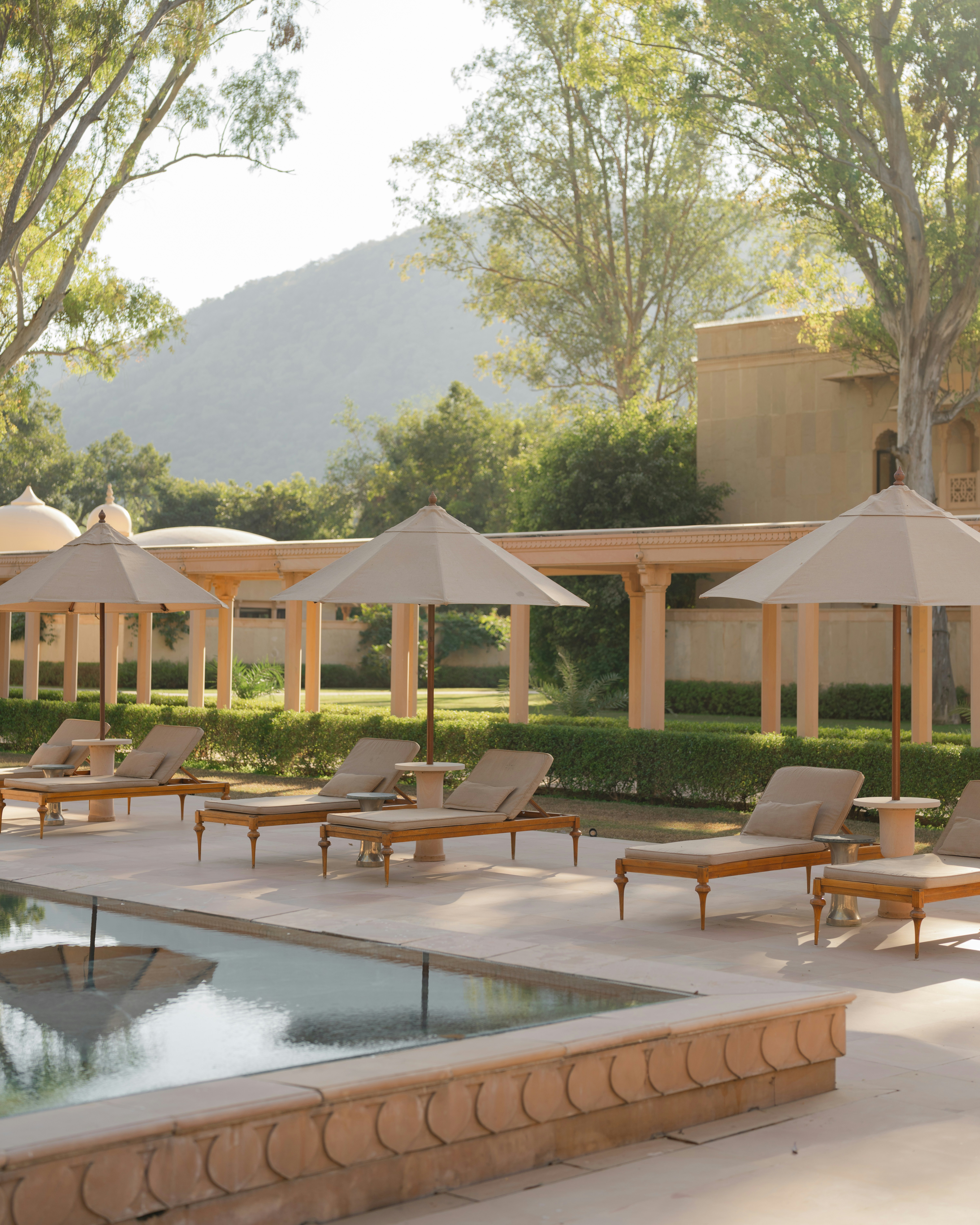 Sunlit Poolside Oasis with Loungers and Umbrellas