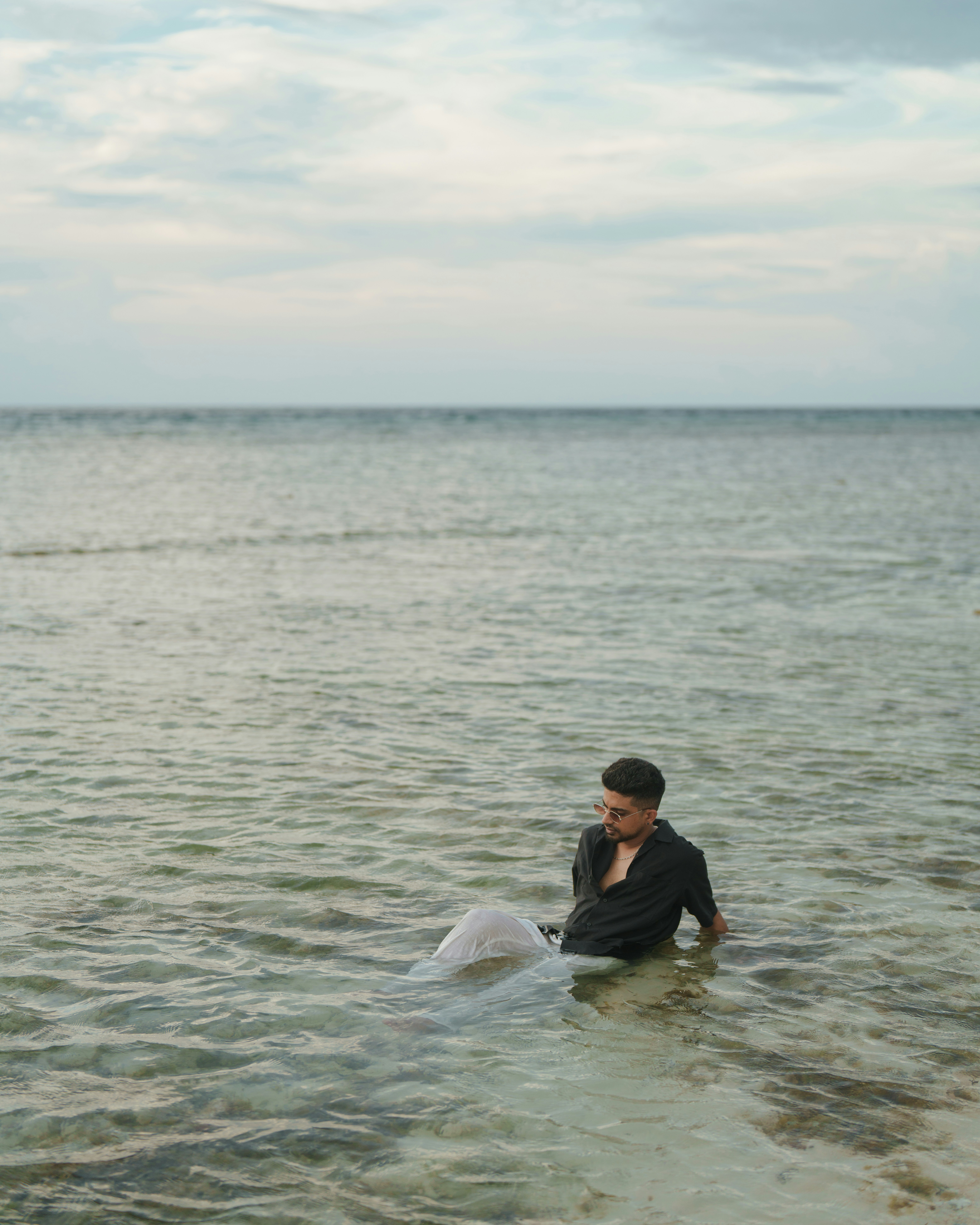 Shoreline Embrace: A Partial Submersion Portrait in Calm Seas