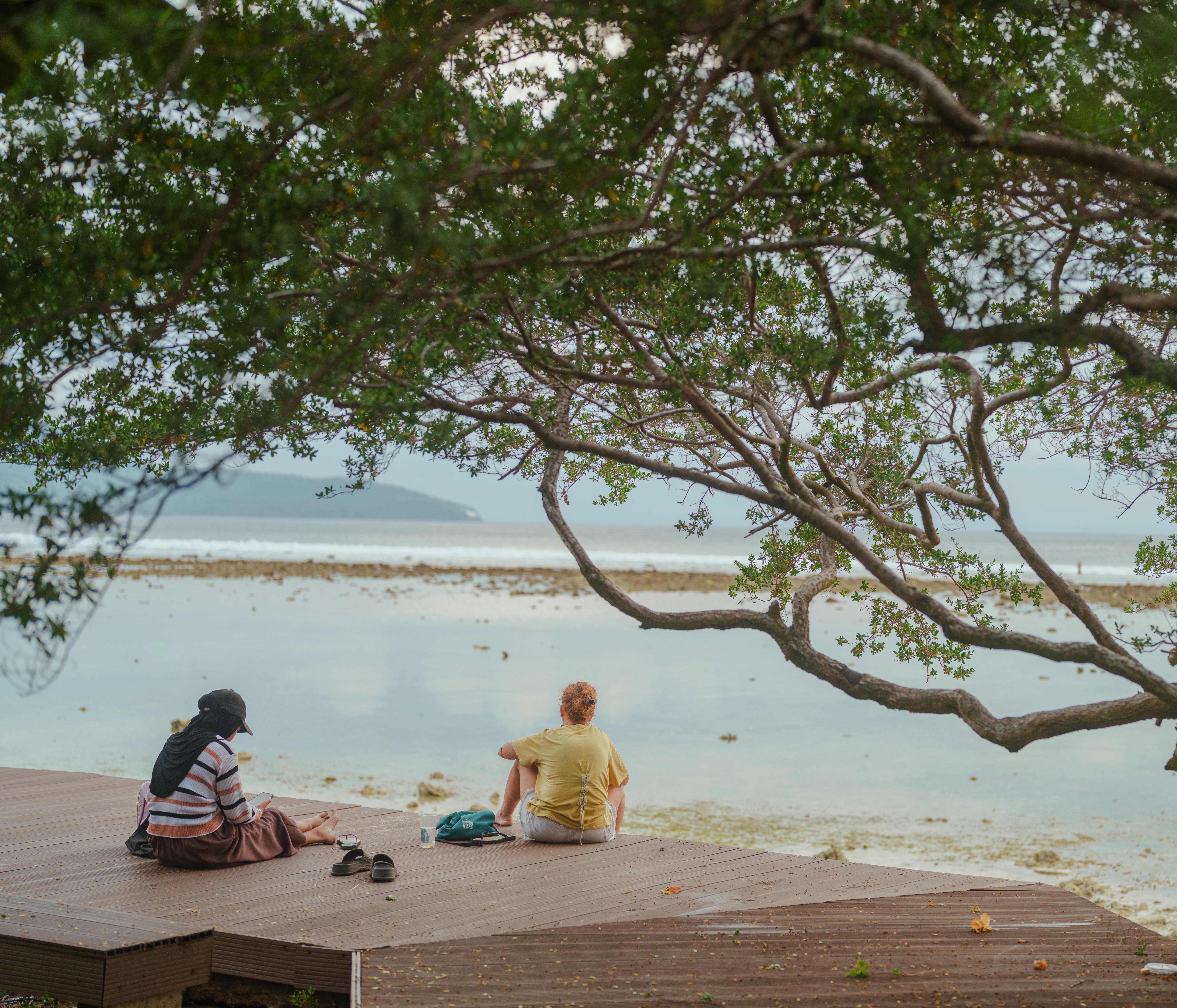 Sea-Edge Reflections: Two Figures on a Quiet Shore