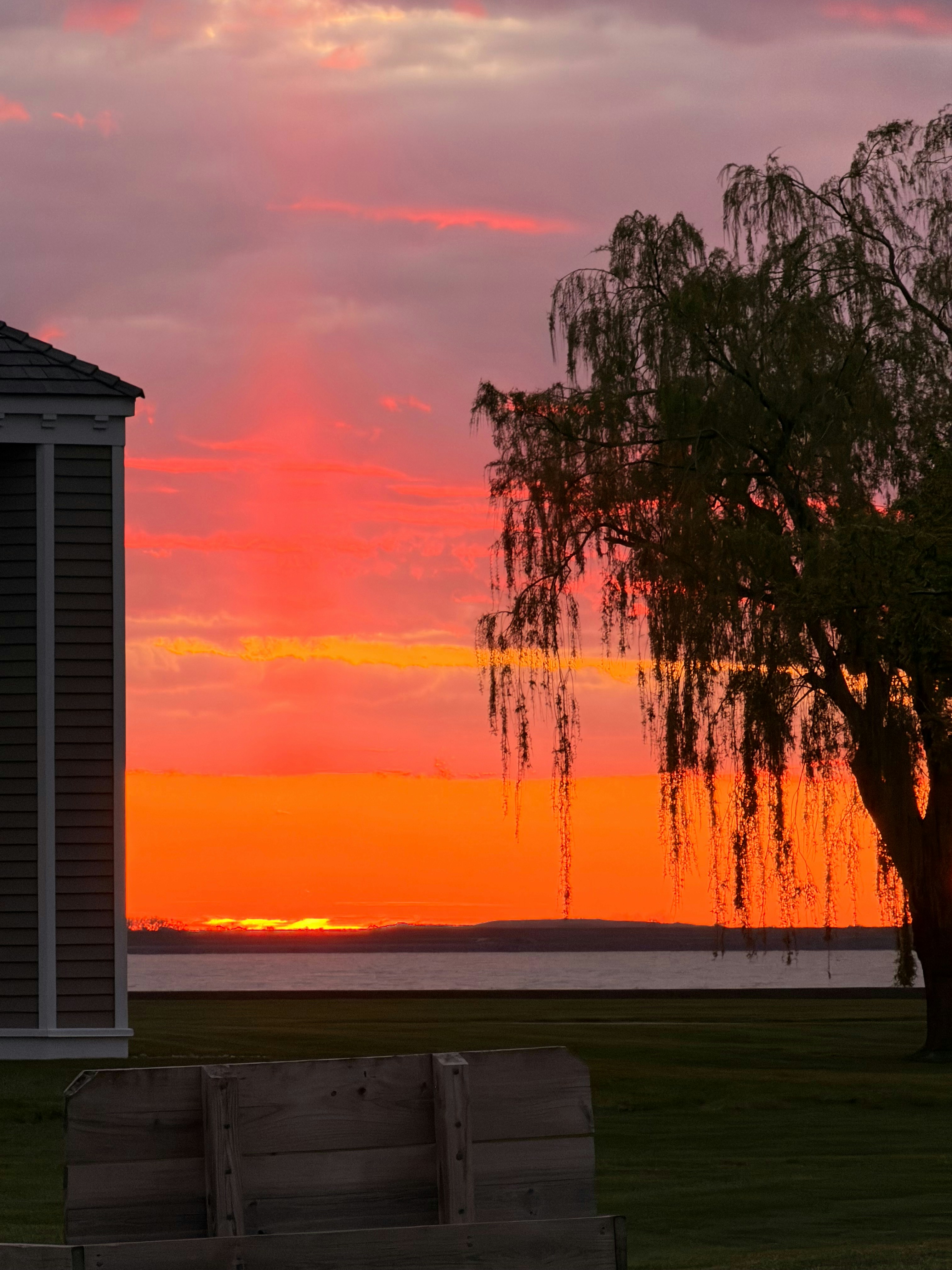 Sunset Silhouette by the Riverside Lawn