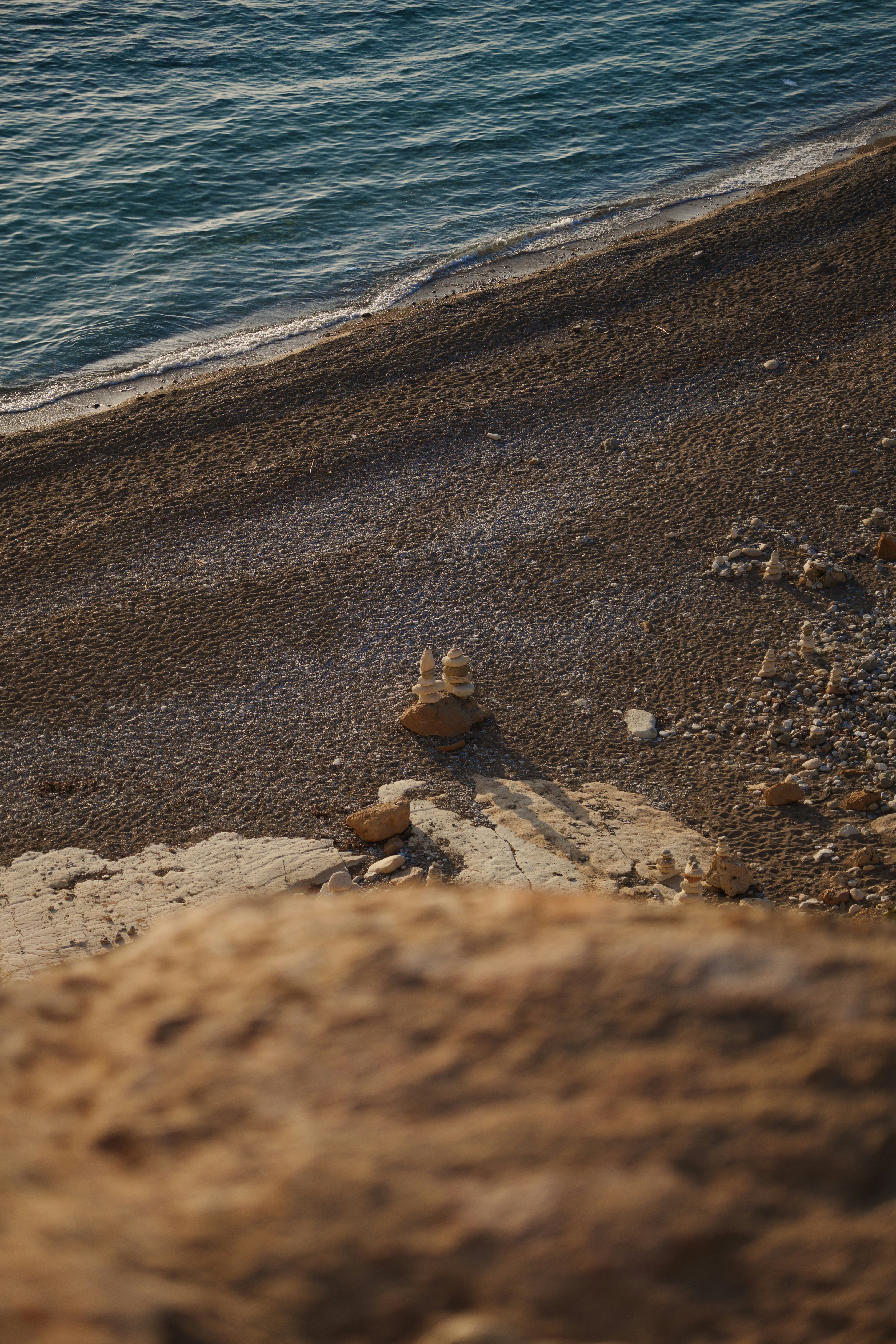 Pebble Stack at the Shoreline: A Quiet Moment on Sloping Beach