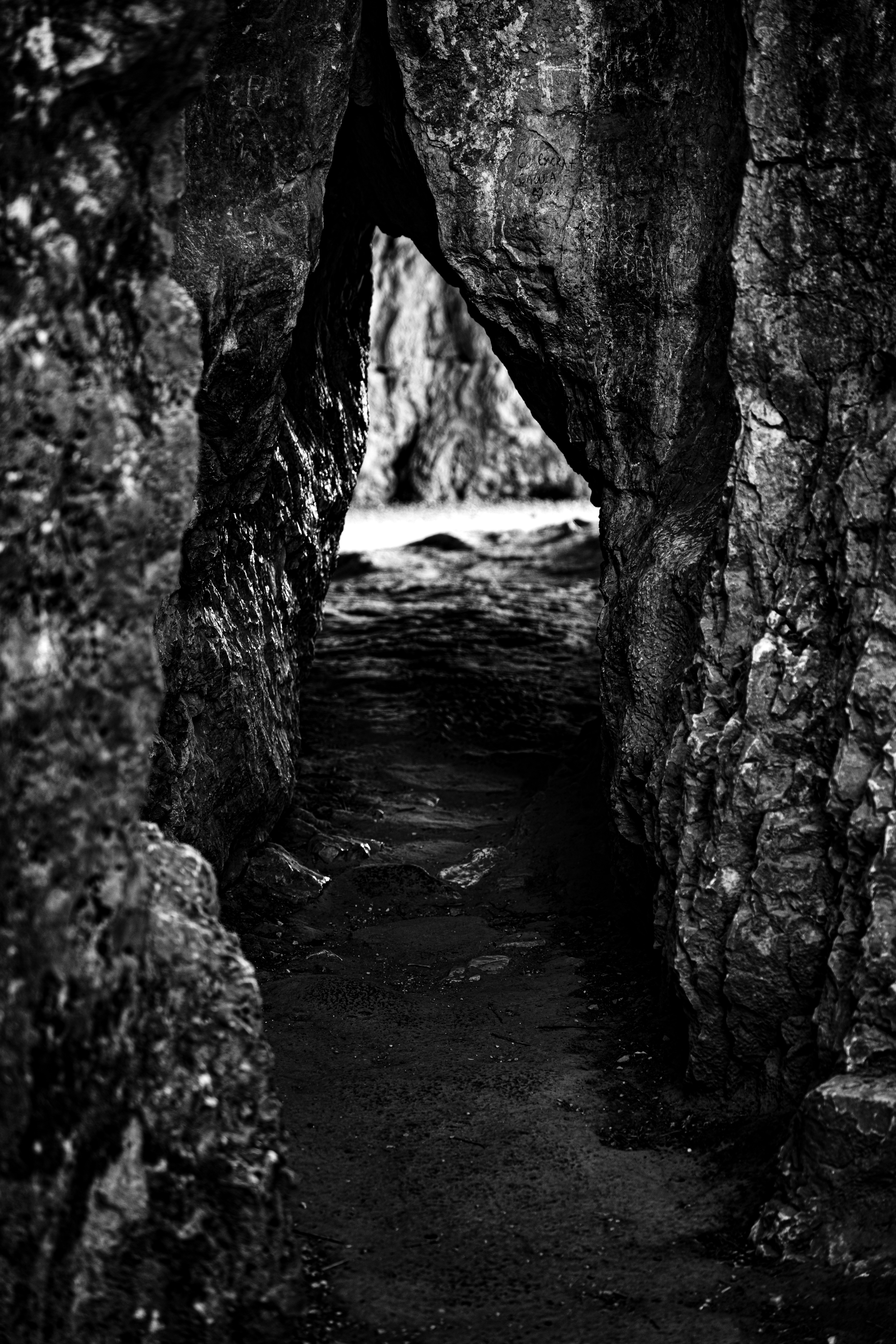 Through the Dark Arch: A Narrow Canyon Gate in Monochrome