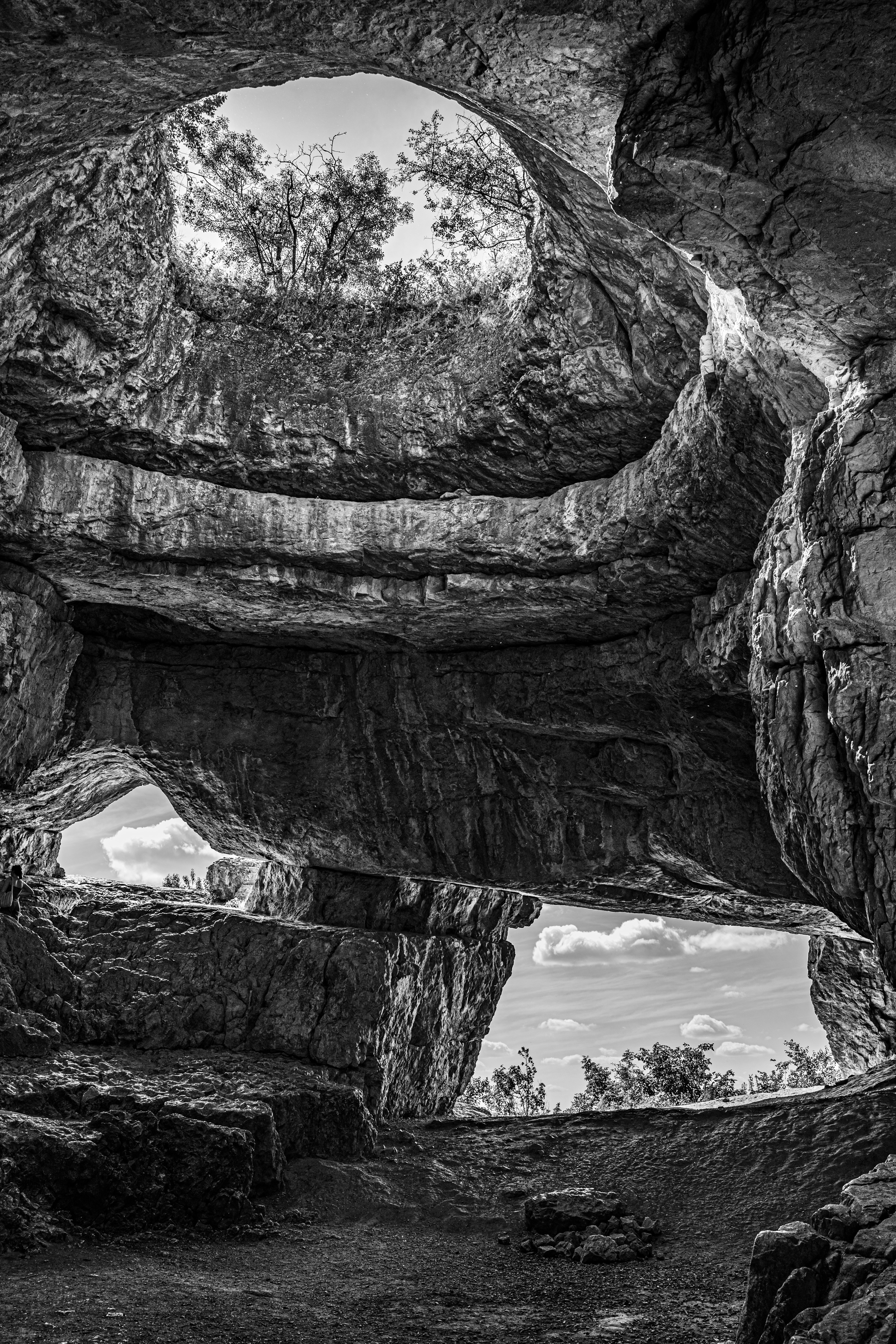 Natural Cathedral: Sunlit Cavern Framing a Sky-window
