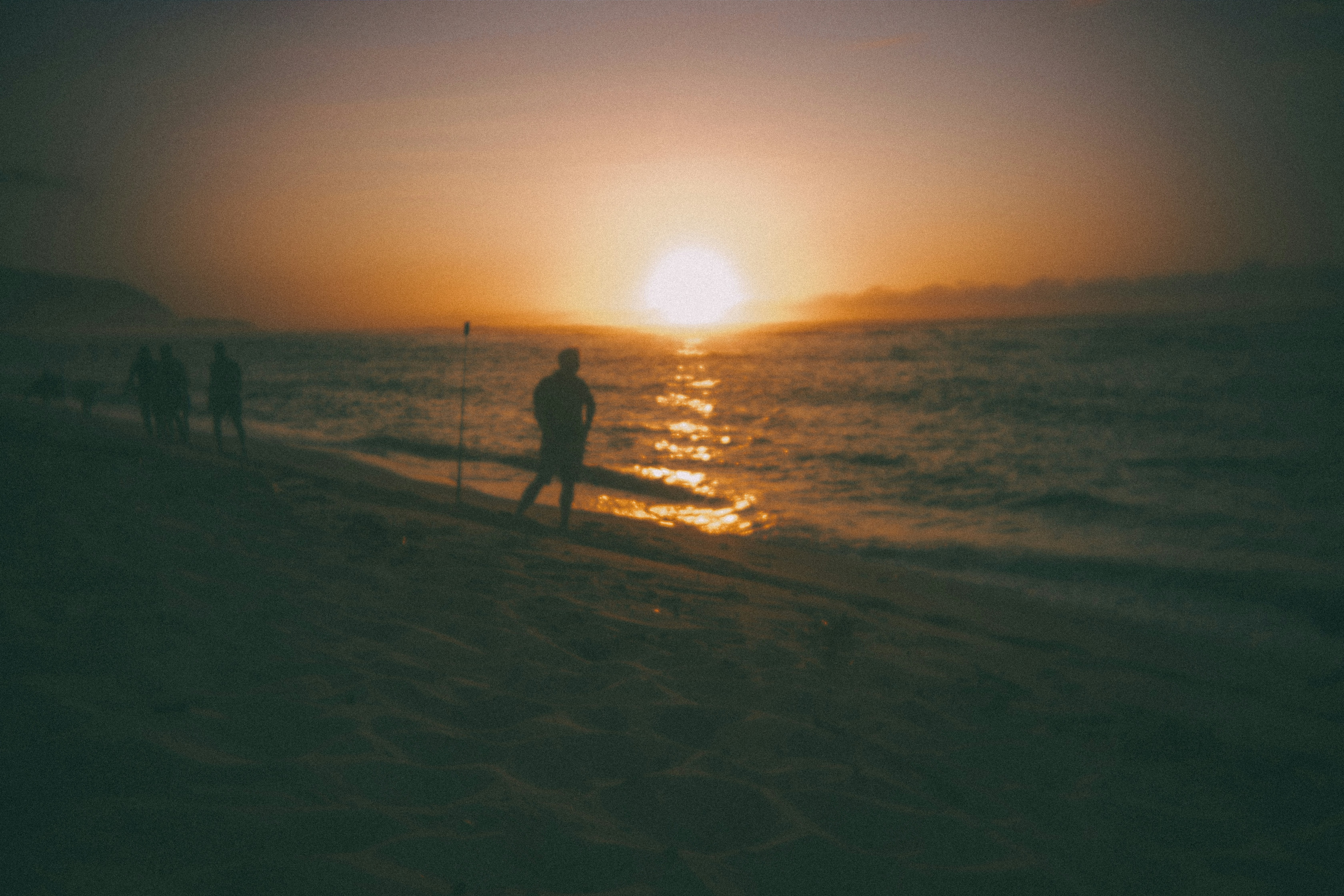 Sunset Silhouette: The Fisherman and the Quiet Shore
