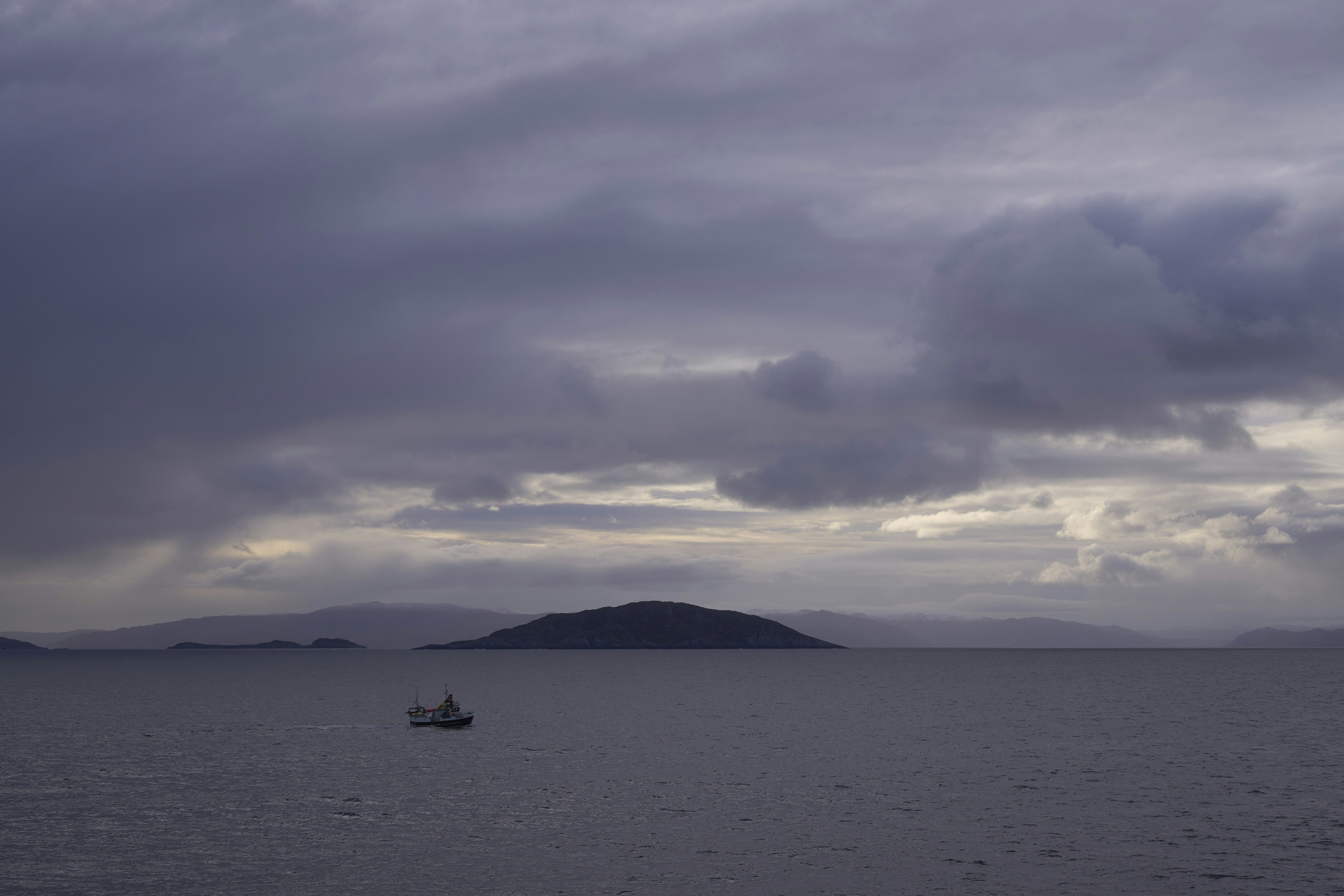 A Quiet Vessel Under a Cresting Sky
