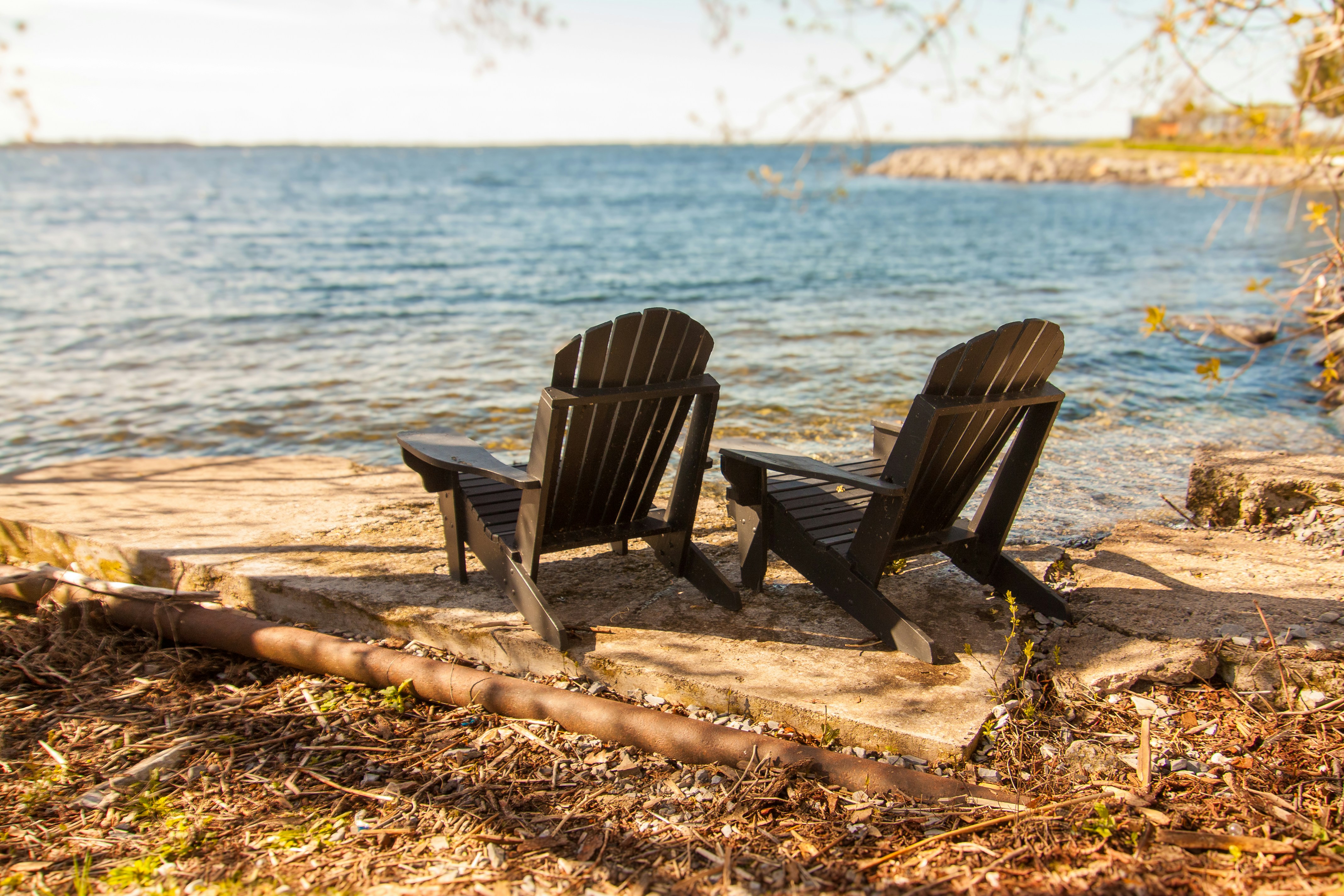 Two Adirondack Chairs Await by a Quiet Lake