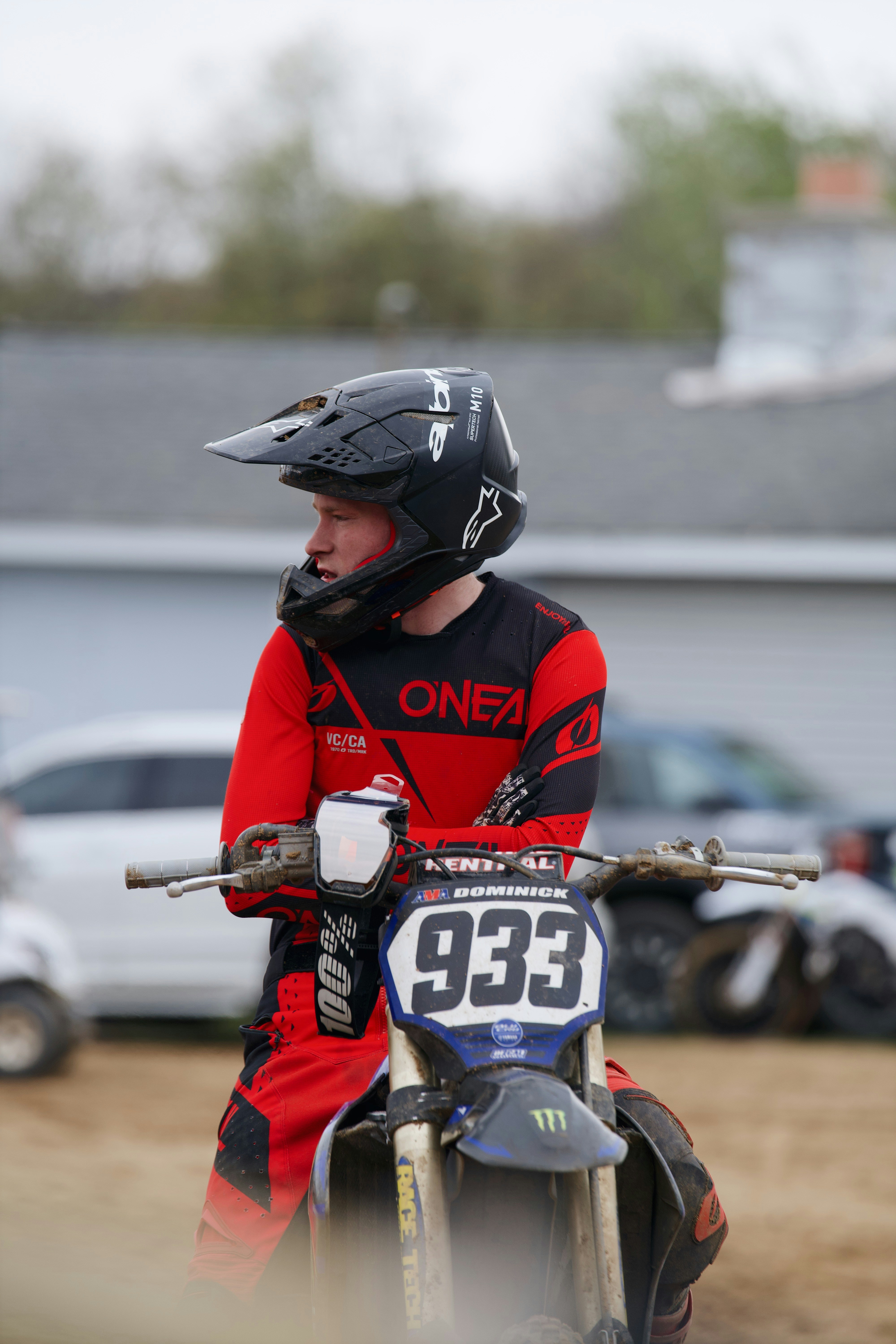 Moto Cross Rider in Red and Black Gear Post-Race at the Track