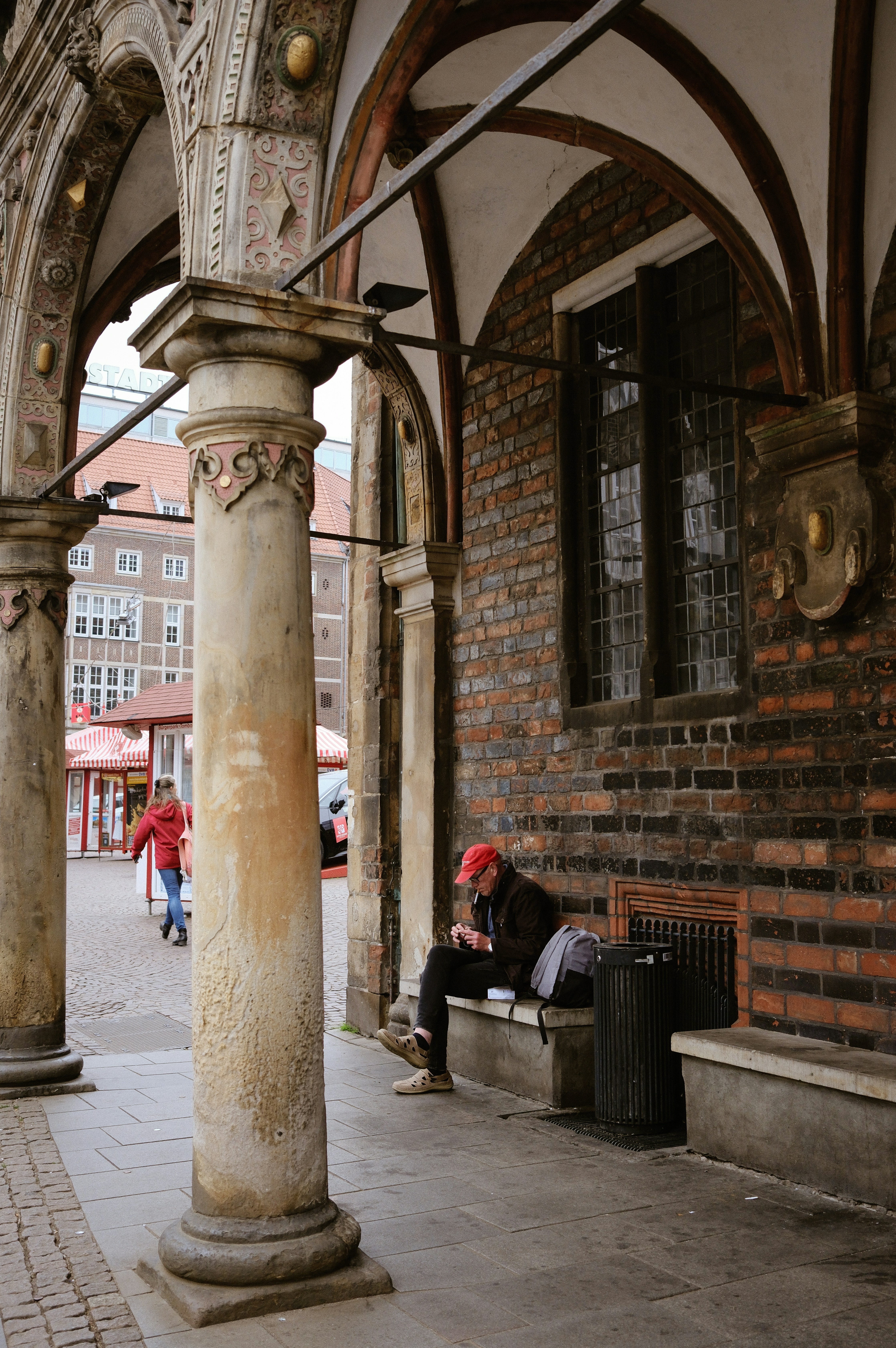 Sheltered Corner: A Quiet Moment Beneath Arched Columns