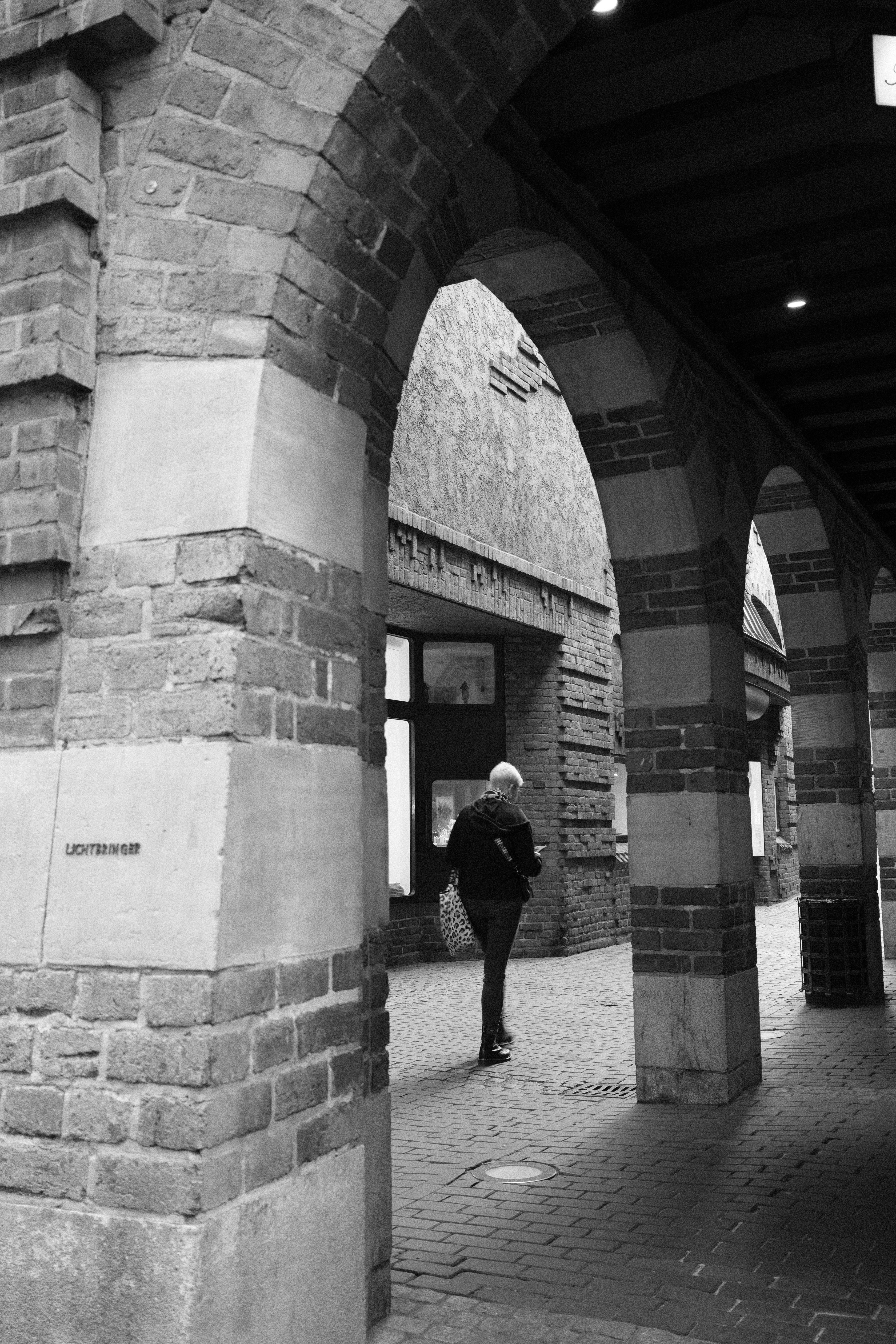 Solitary Presence Under Stone Arches