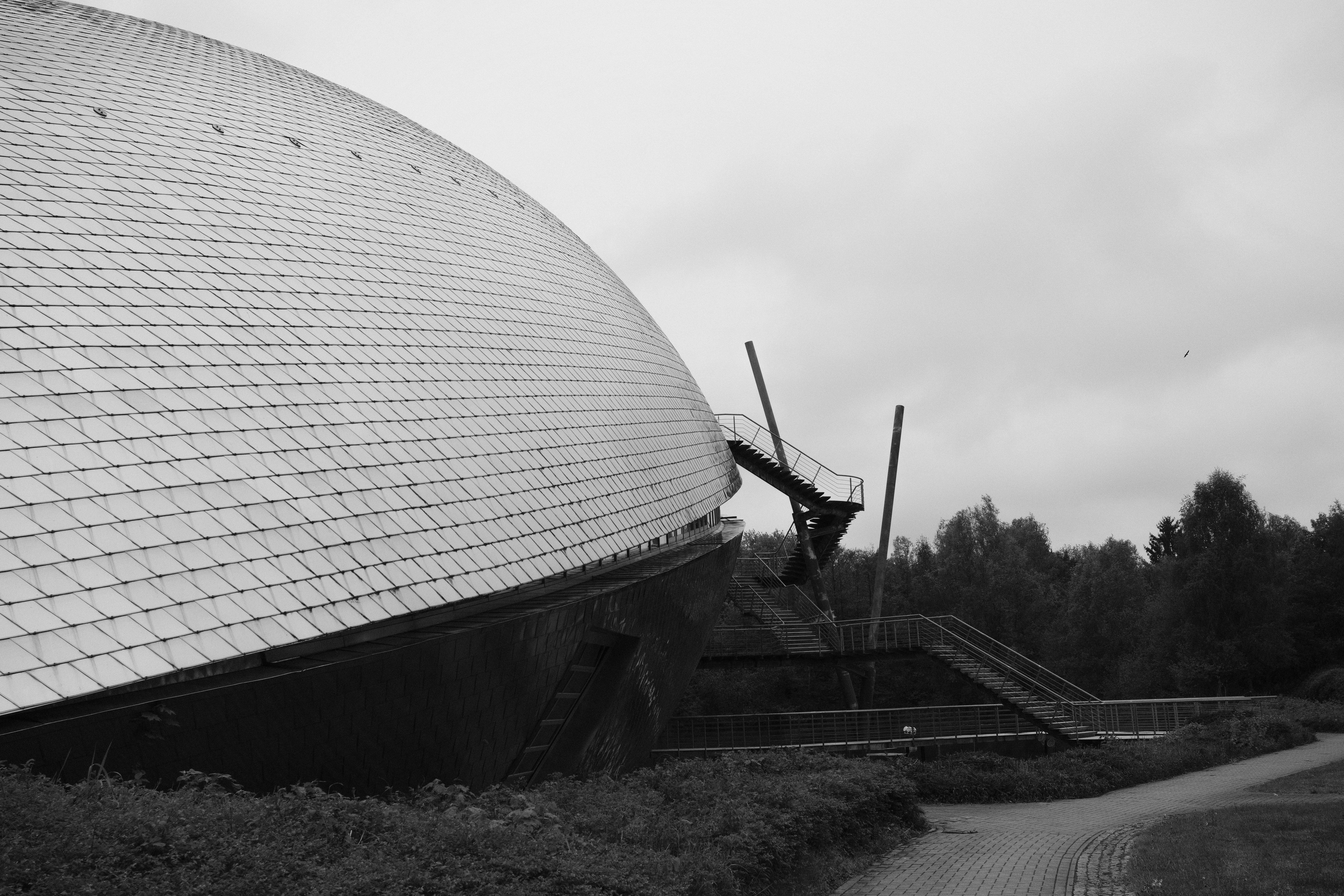Curved Silver Dome Overlooked by Woodland Path