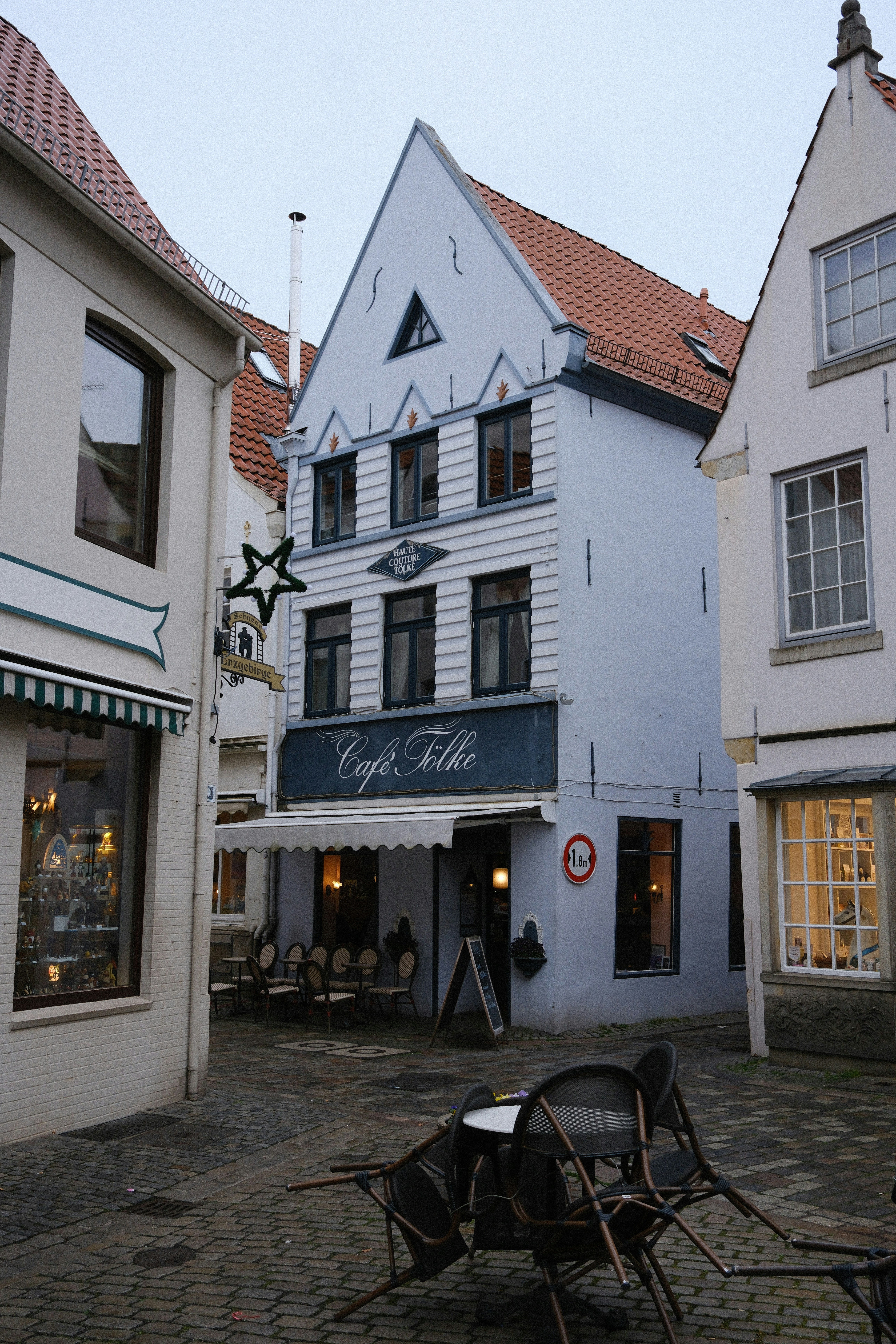 Cobbled Lane Bistro Nestled Between White Facades
