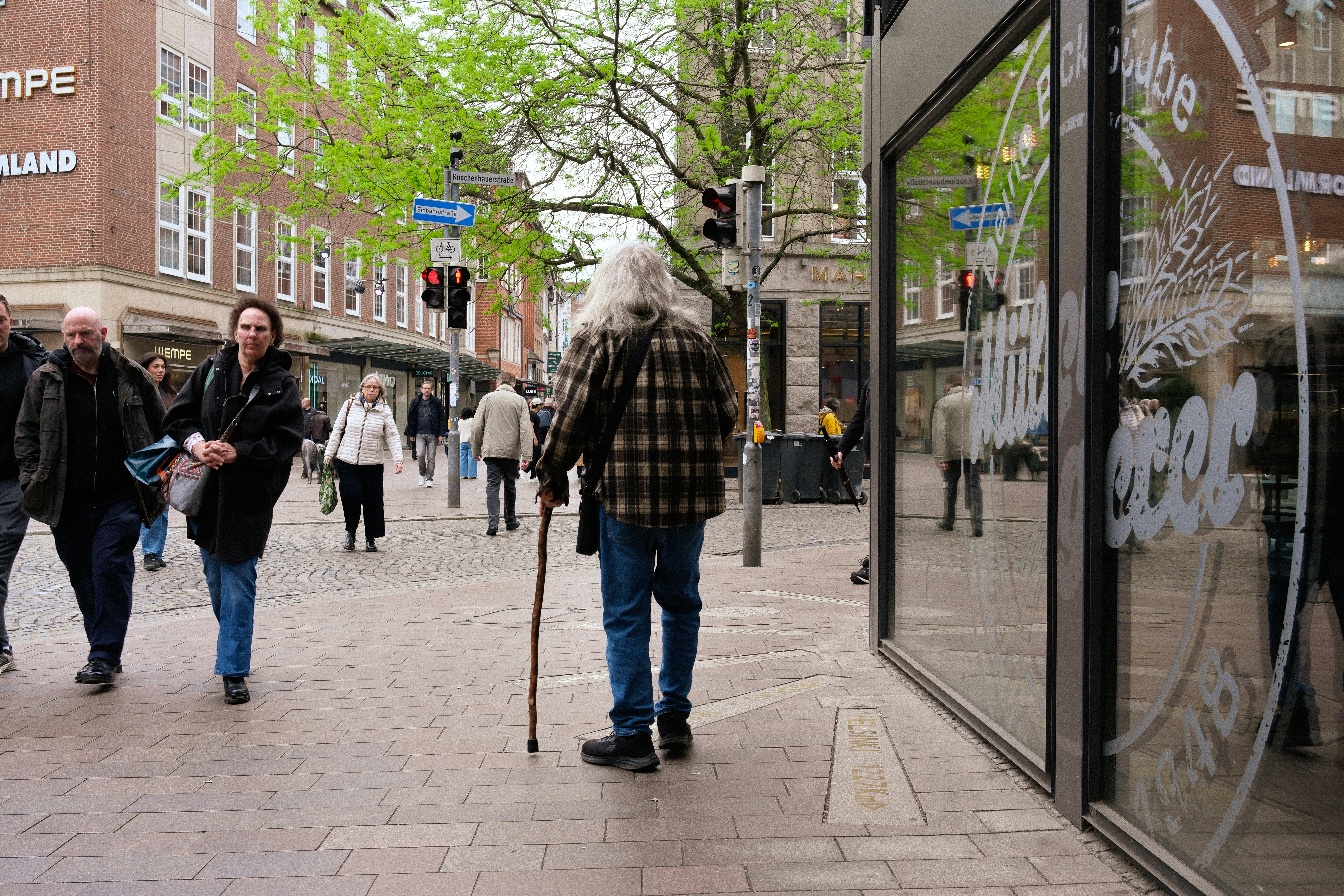 Passing Stranger: A City Moment Framed by Reflections