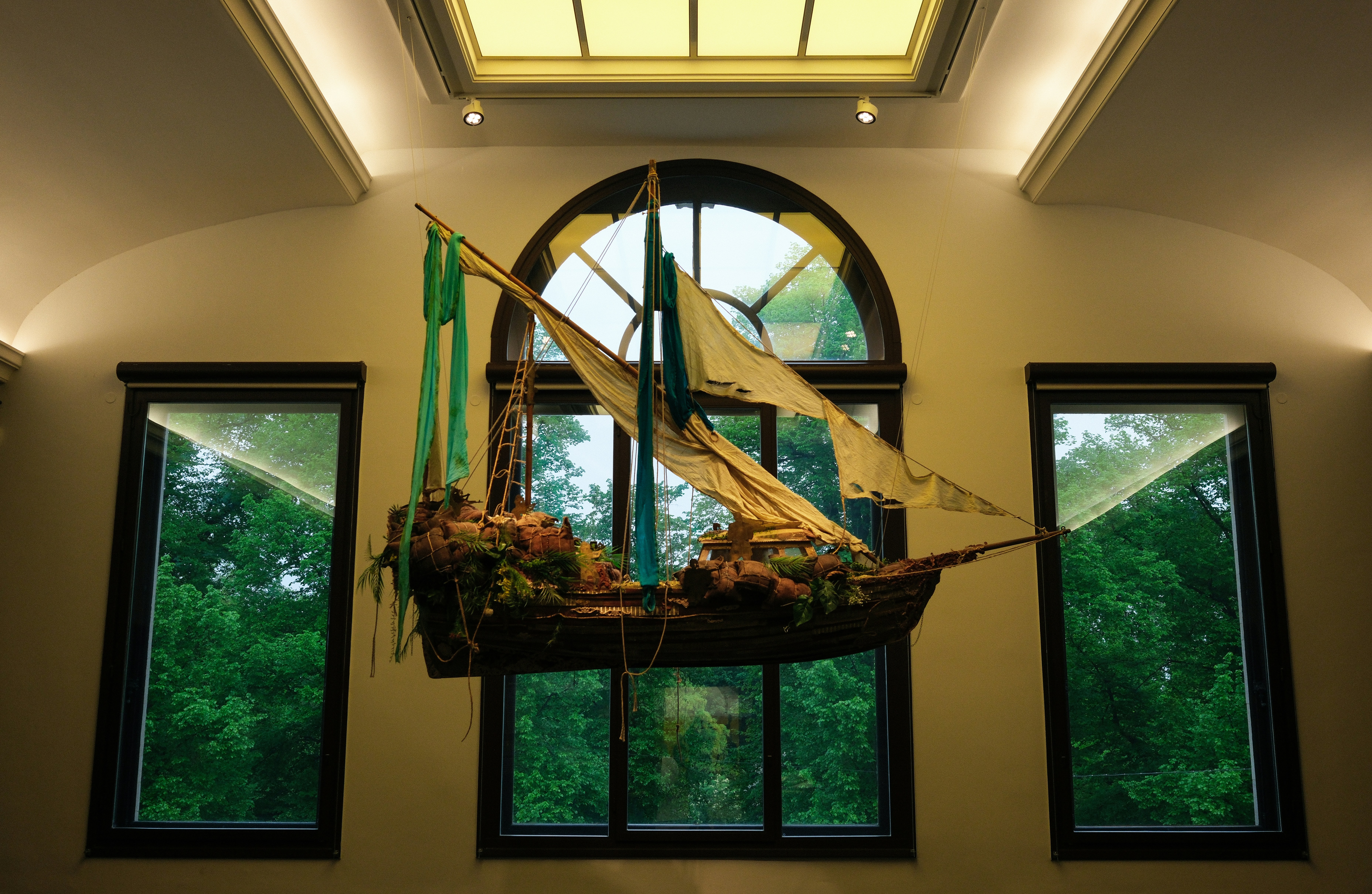 Floating Craft: A Miniature Galleon Suspended in a Sunlit Hall