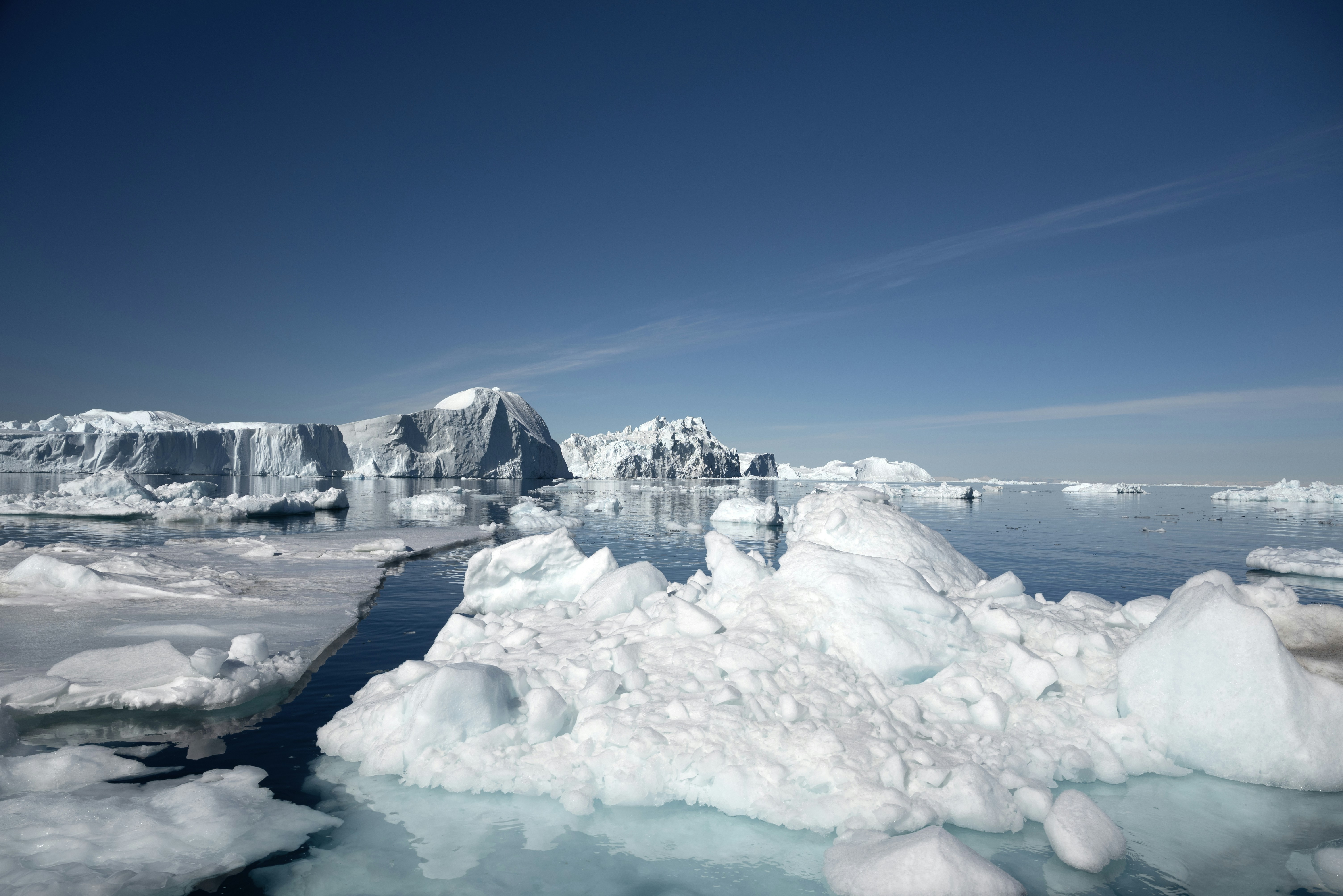 Glacial Reach: Icebergs Float in a Pristine Arctic Channel