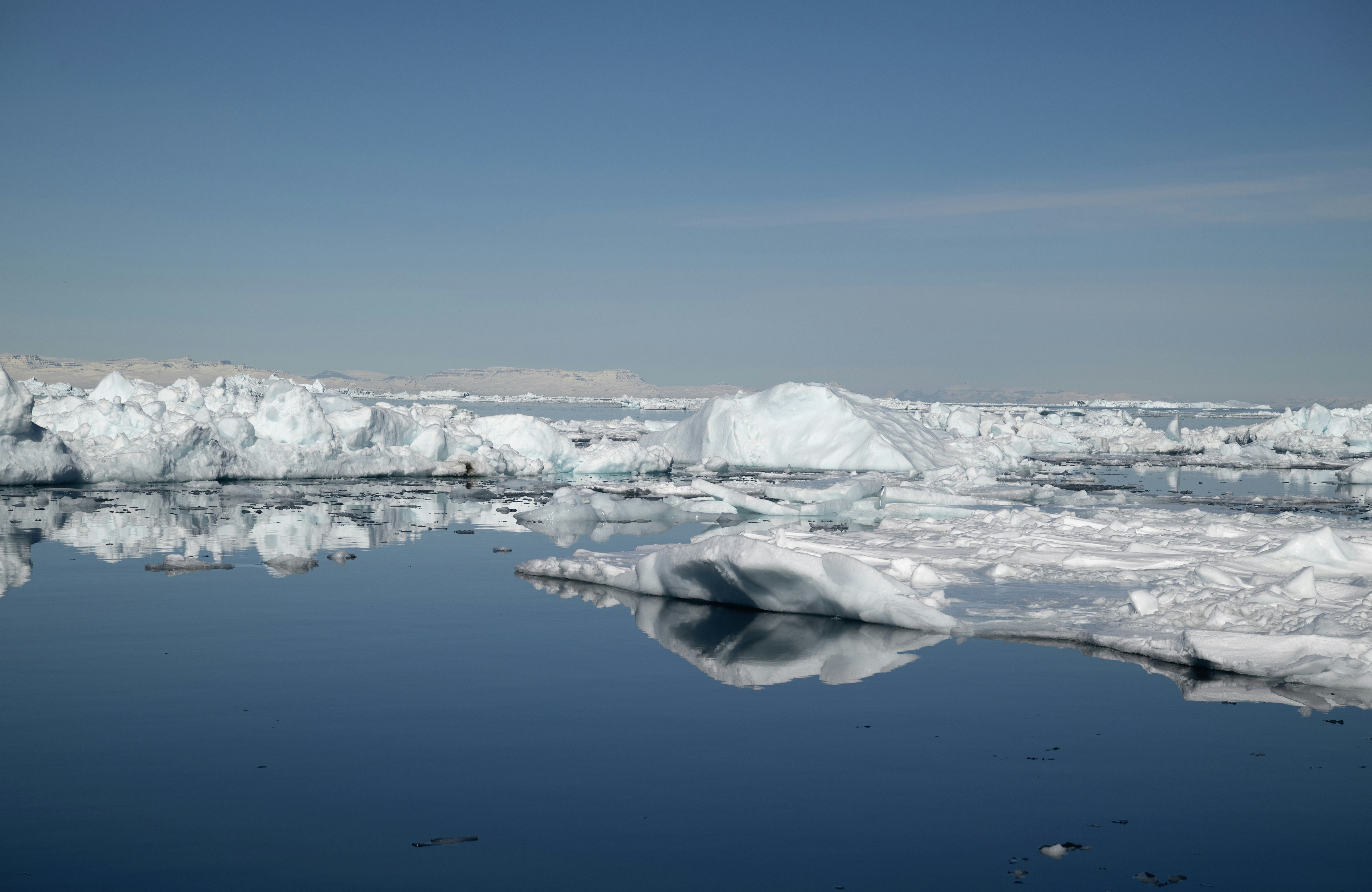 Ice Field Mirror: A Lone Iceberg Anchored by Still Waters