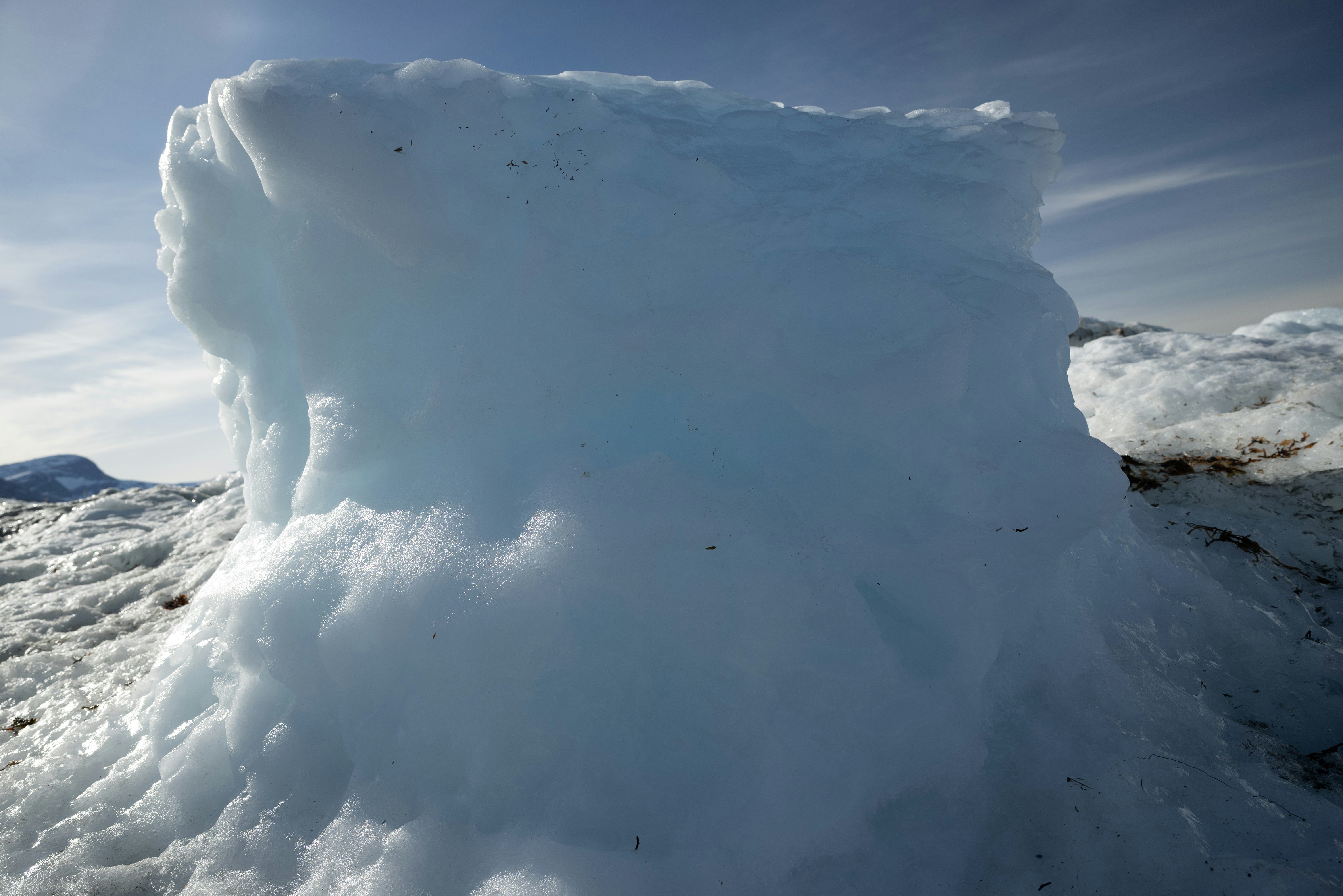 Glacial Sentinel: A Massive Ice Block Against a Clear Sky