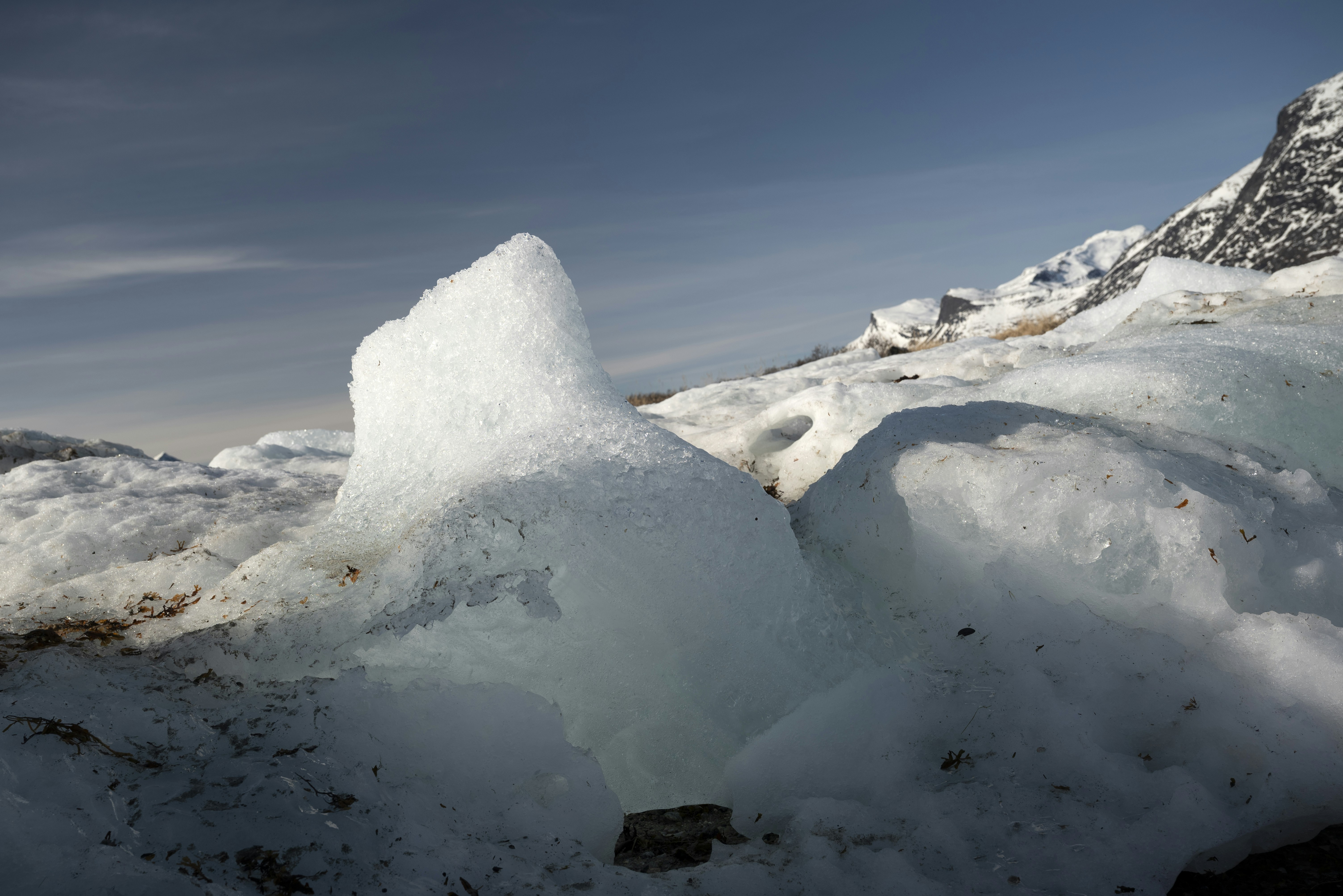 Ice Cathedral: A sculpted iceberg under a clear alpine sky