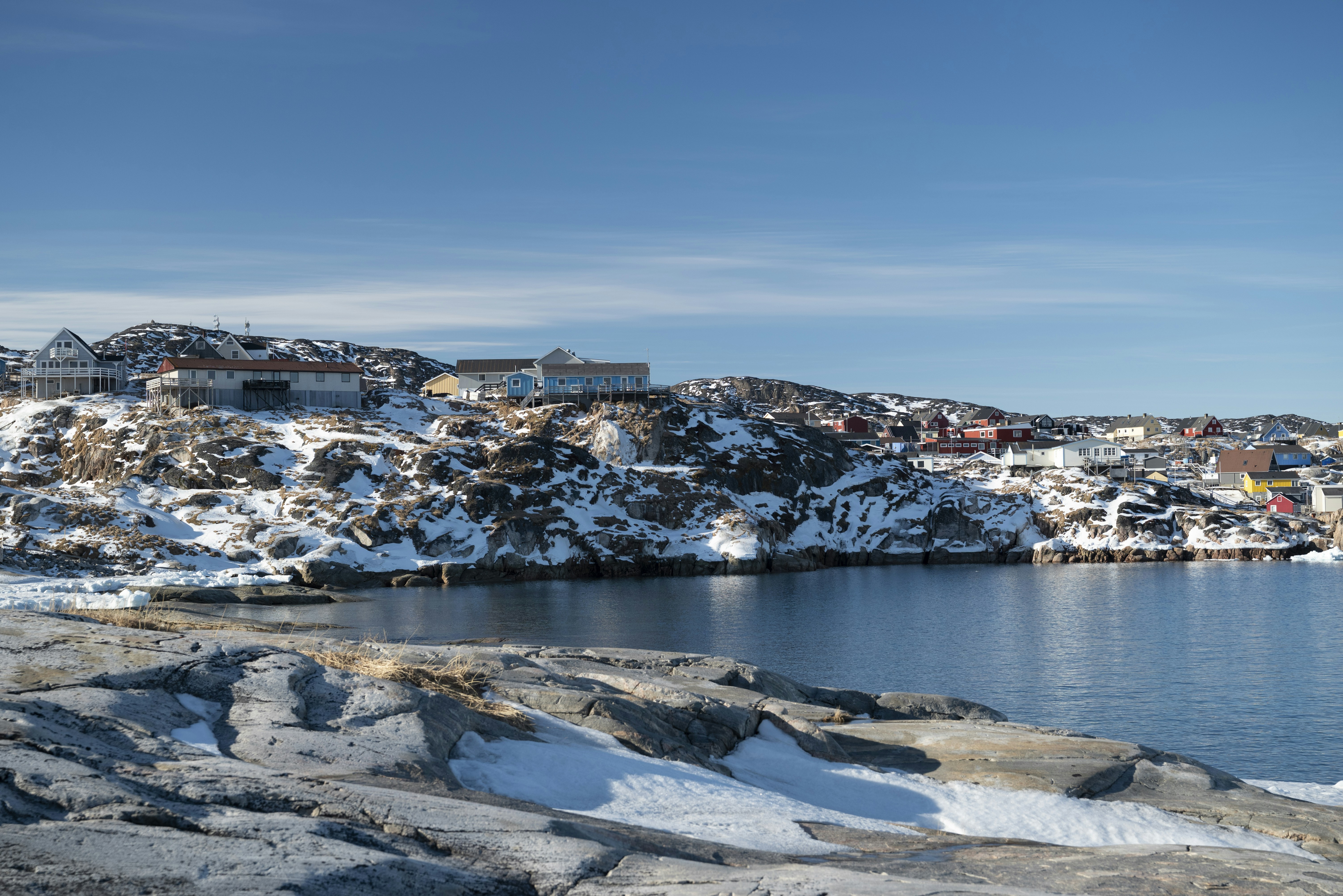 Snow-Capped Coastal Village Basking Under a Clear Blue Sky