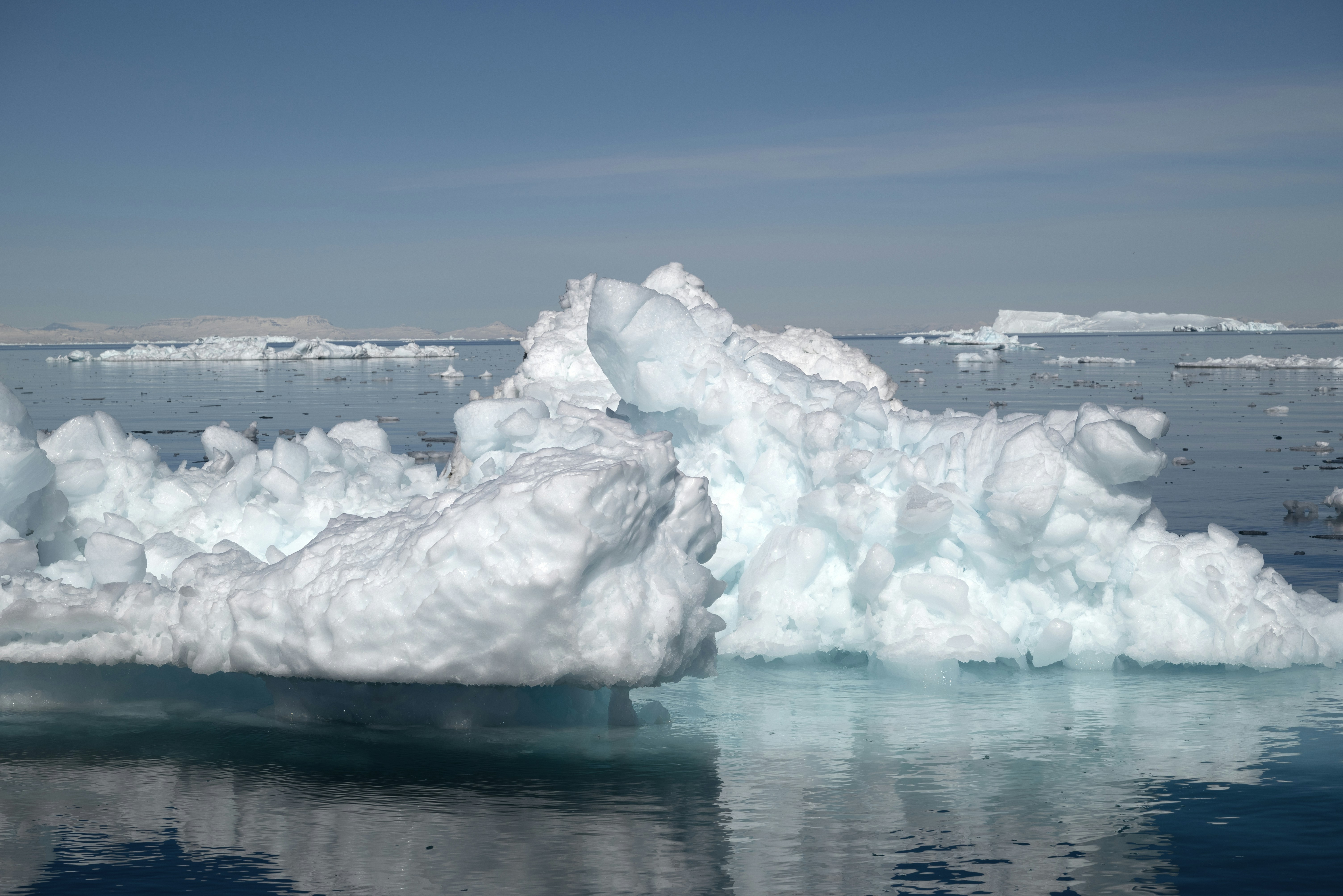 Icebound Horizon: A lone iceberg amid a calm Arctic sea