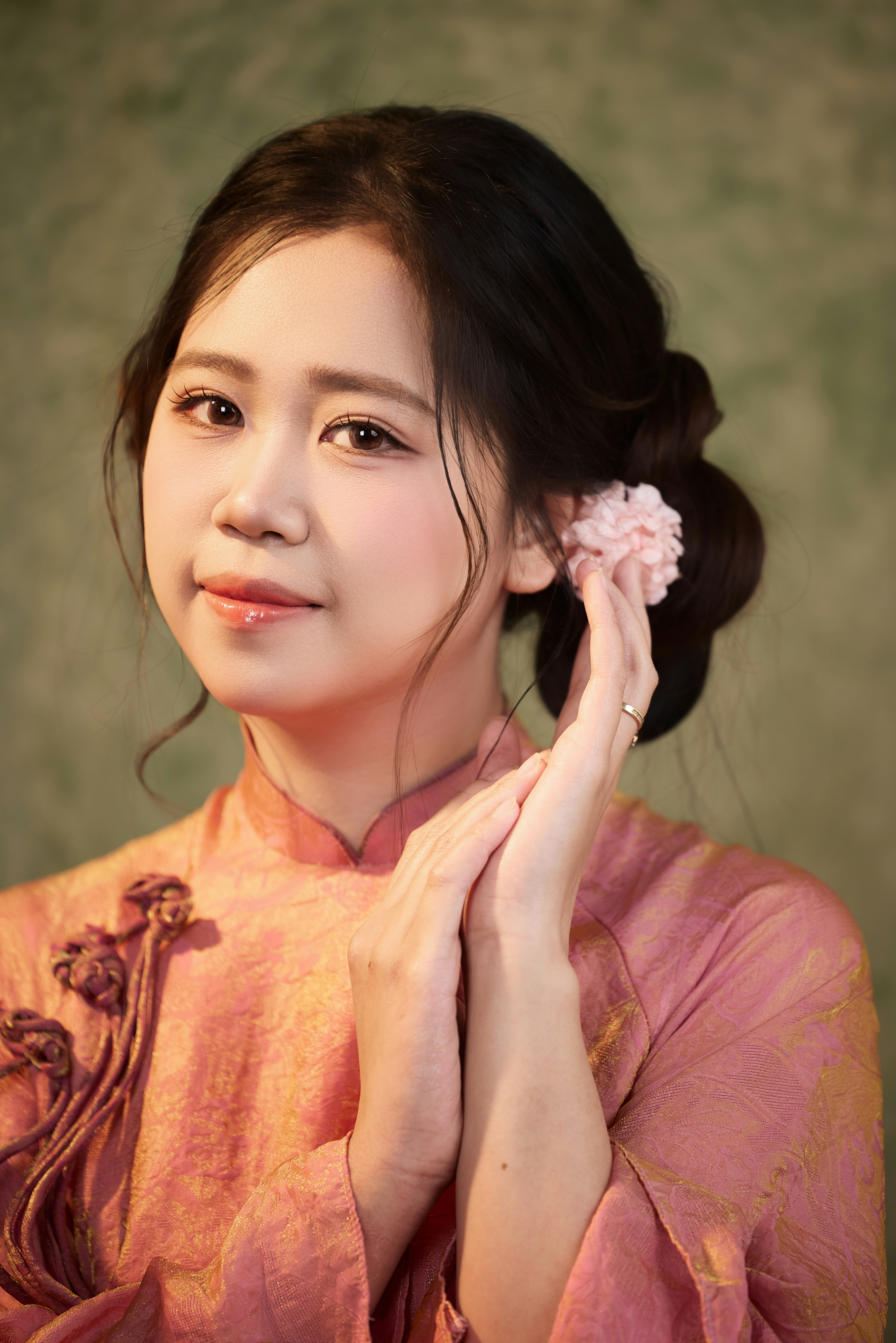 Soft Elegance in Pink: A Portrait with Gentle Gesture