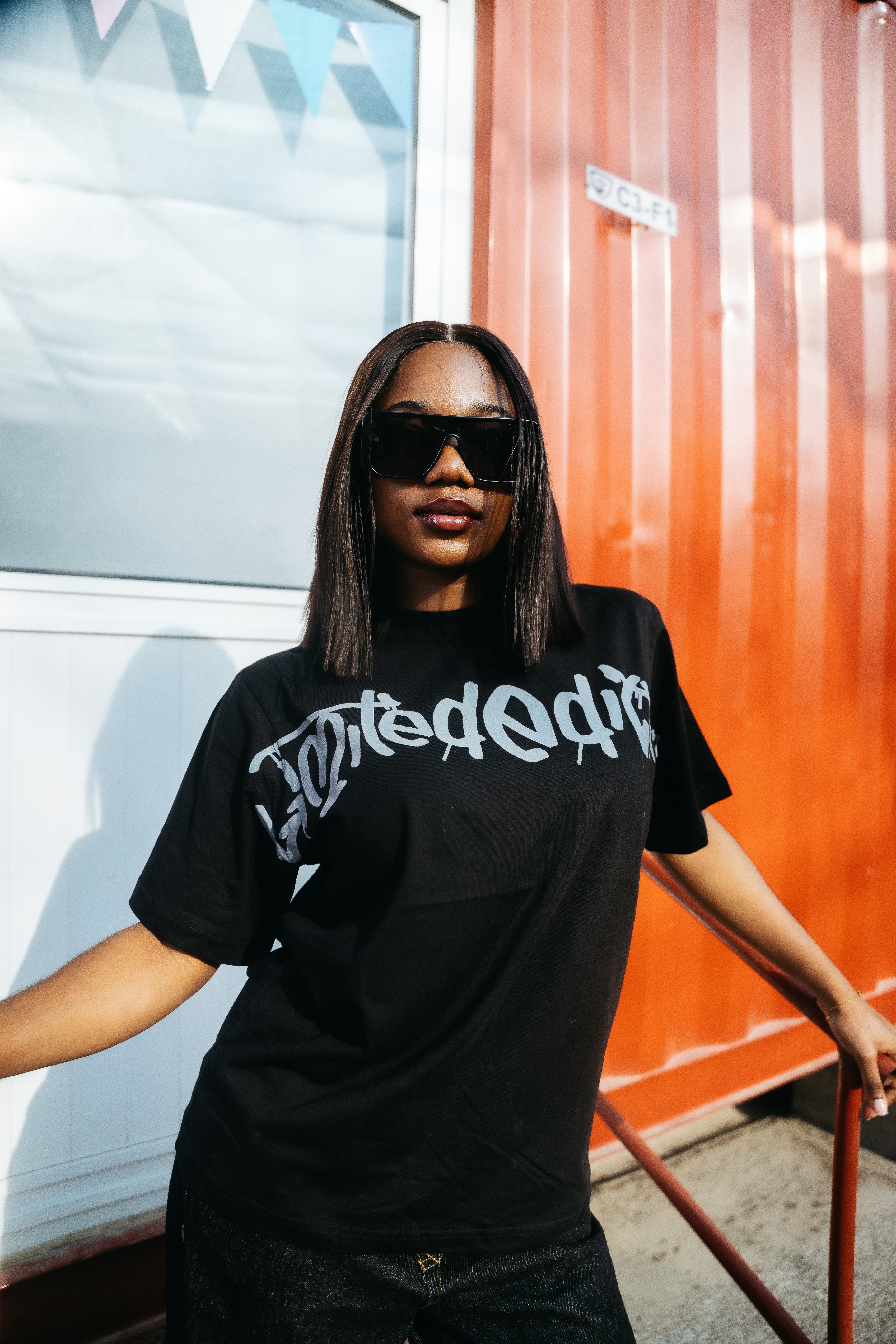 Bold Portrait in Front of a Bright Orange Warehouse