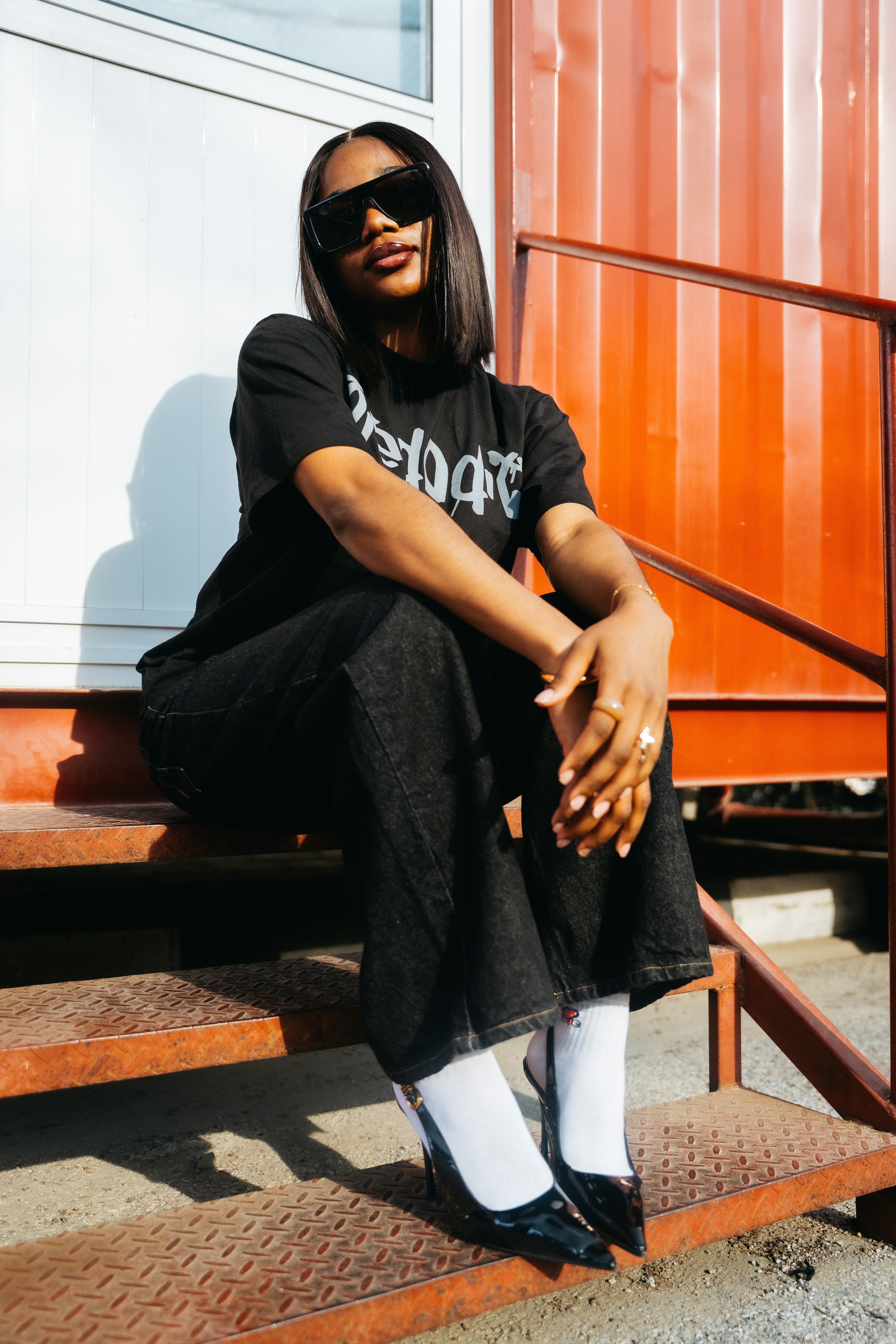 Urban Cool: Shadowed Confidence on Steel Steps