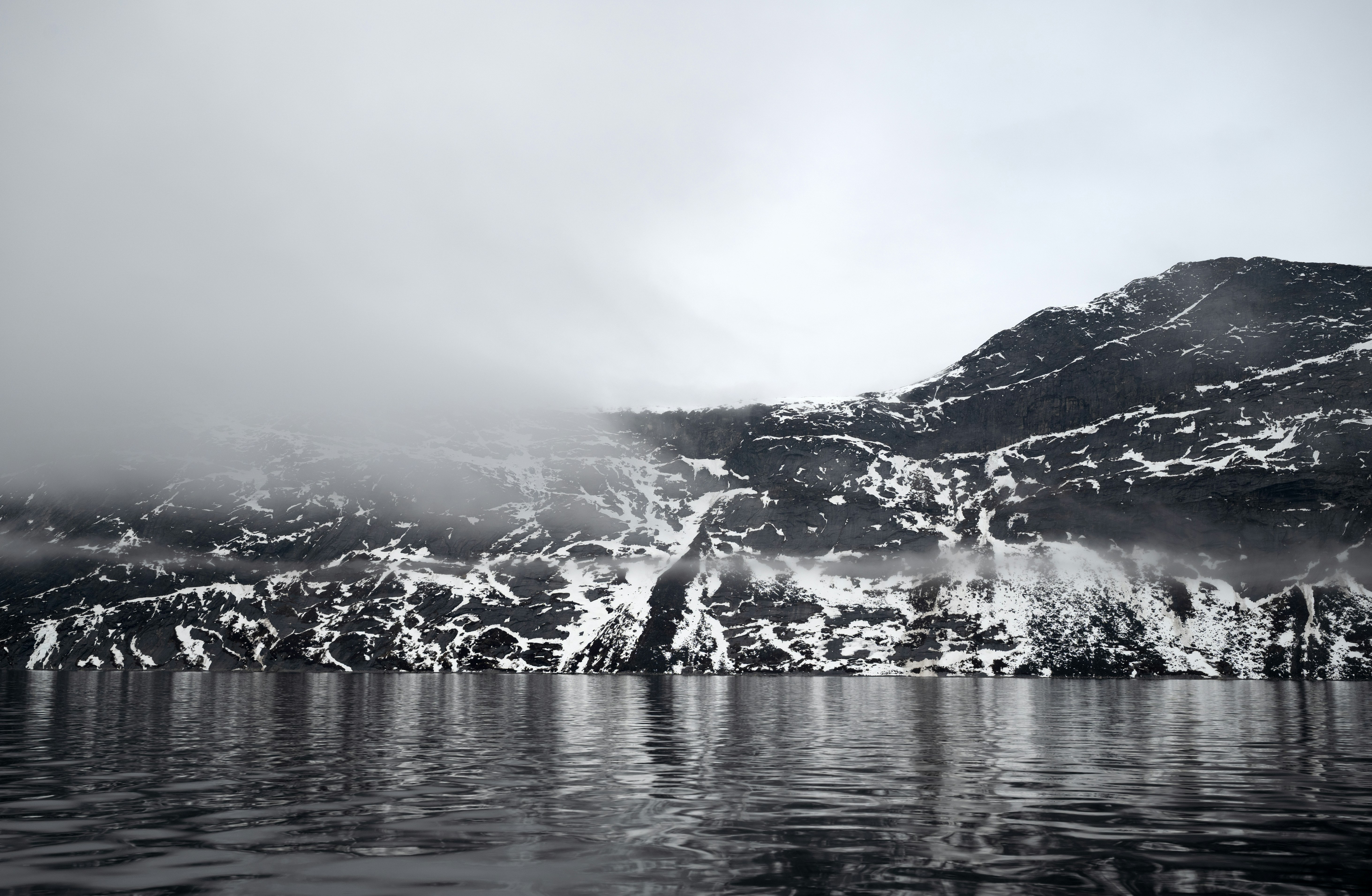 Low-Lying Mist Over Icy Cliffs at Dusk
