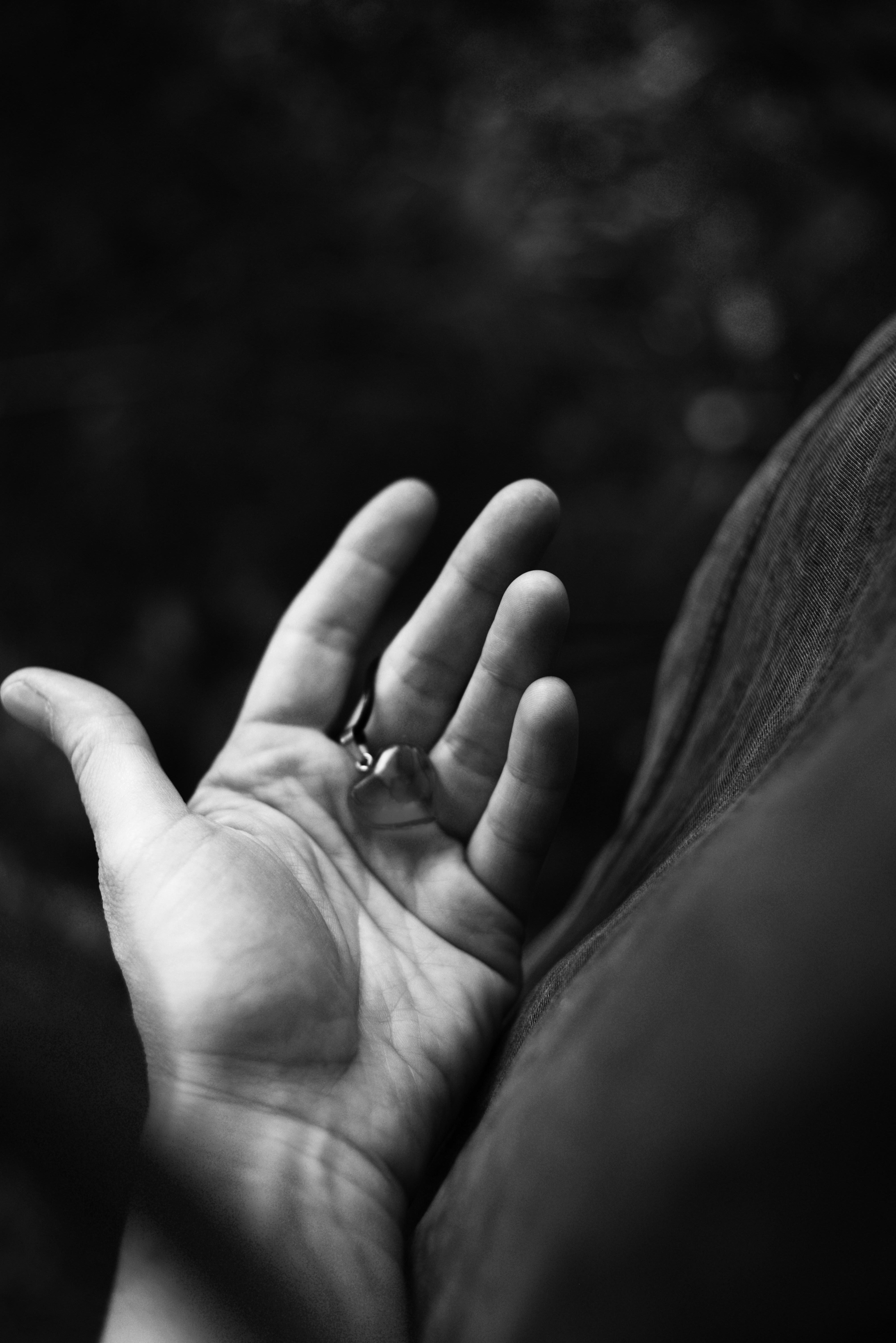 Open Palm, Quiet Light: A Black-and-White Moment of Solace