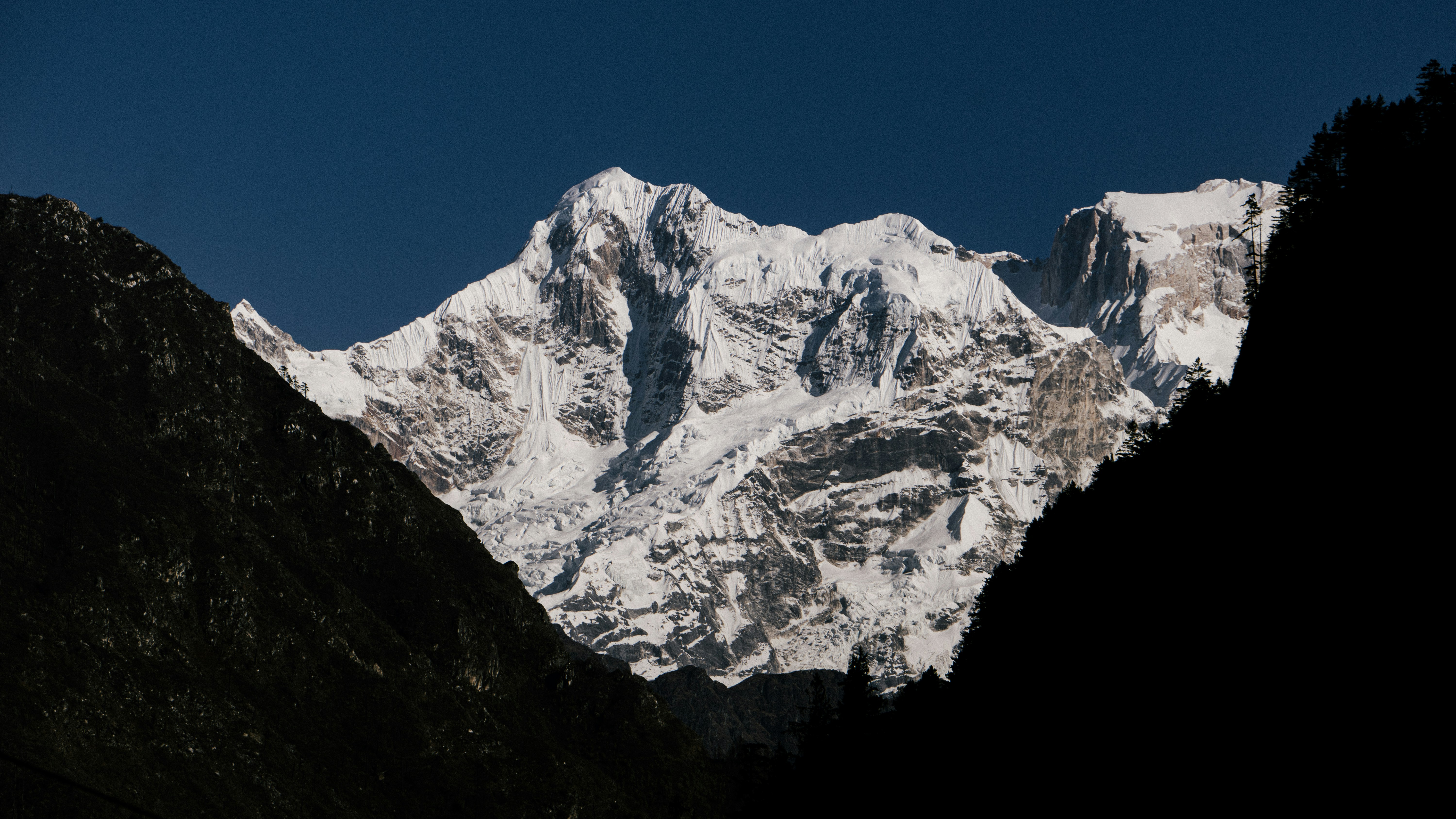 Crested Peaks Above a Shadowed Valley