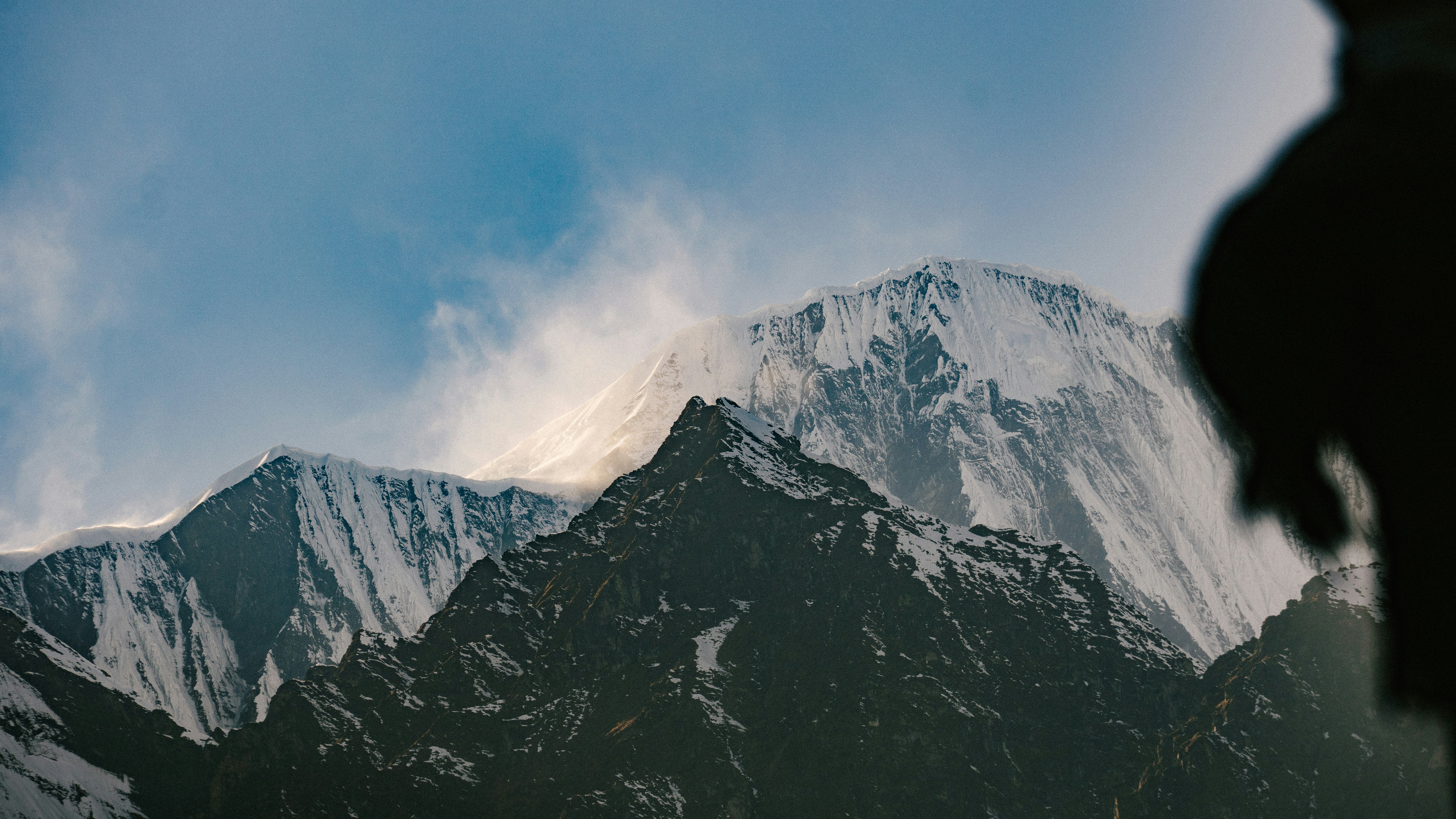 Snow-Crowned Peak Pierced by Cloud