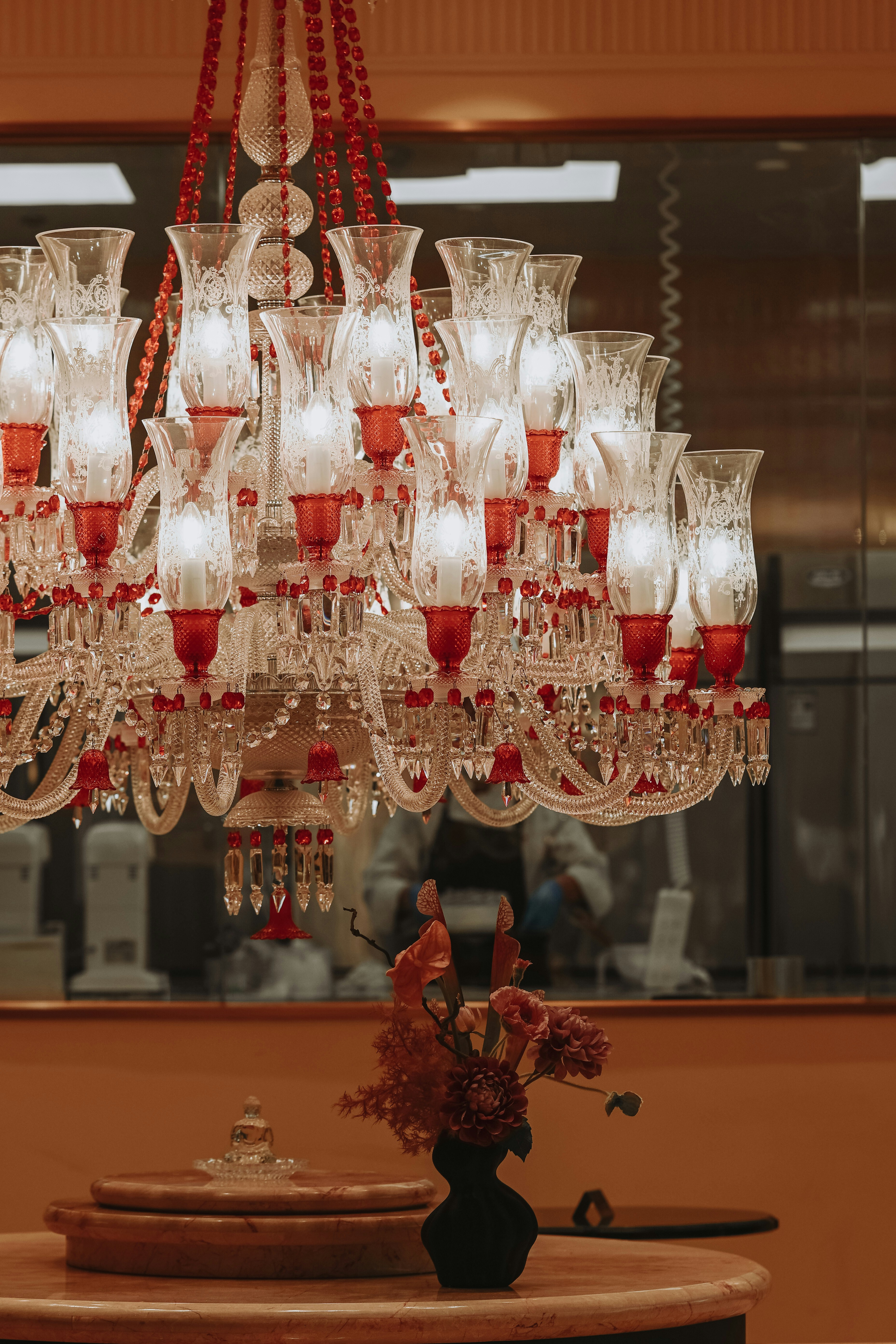 Crystal chandelier glow above a floral centerpiece