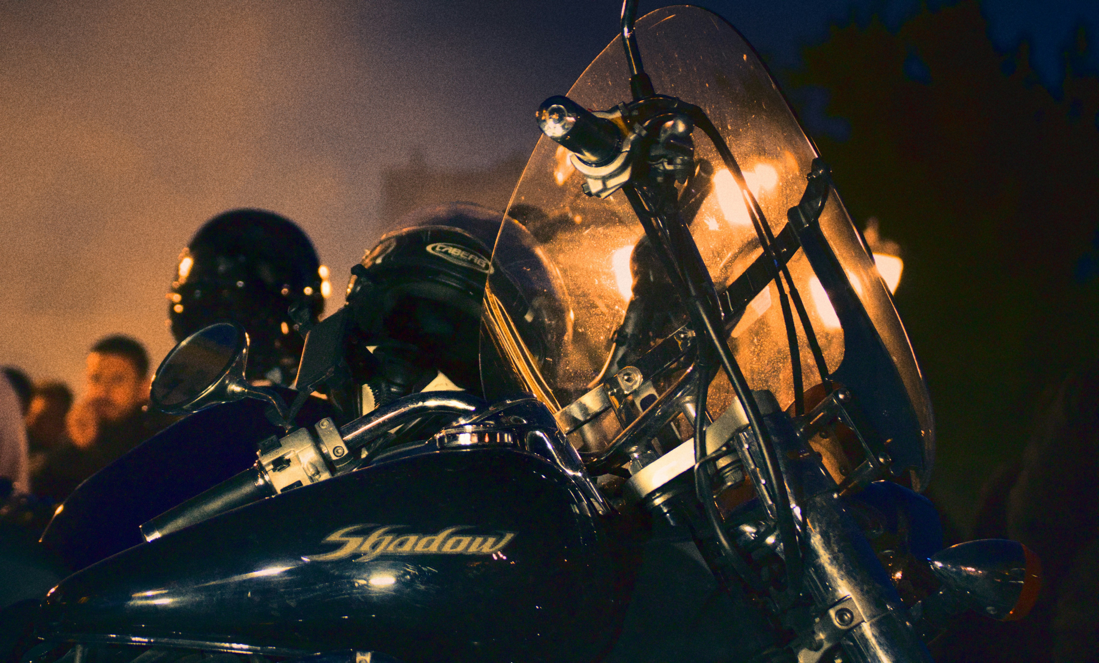 Night Vigil on Steel: A Shadowy Harley Amid Neon Heat