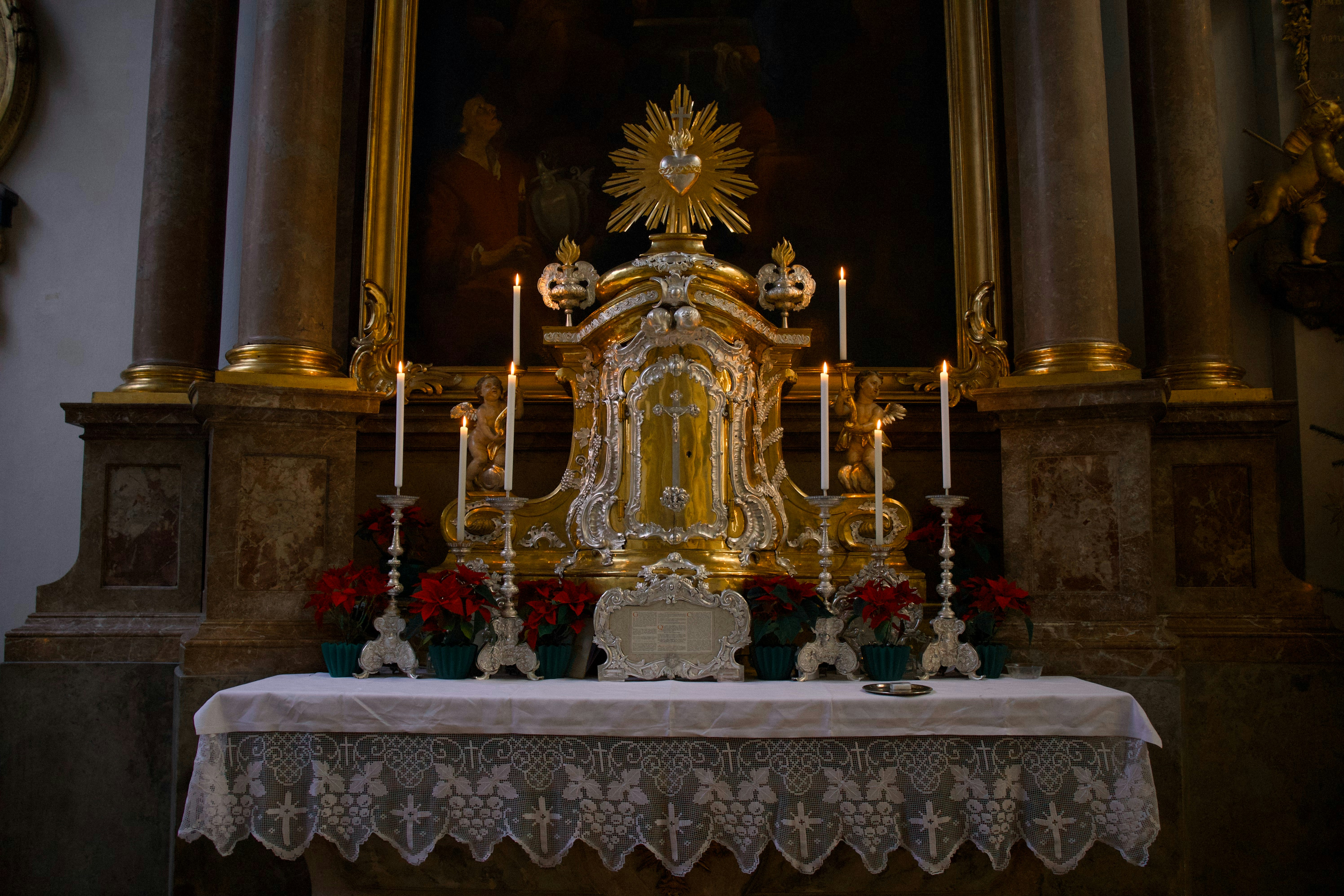 Sacred Adornments: A Candlelit Altar Centered in Ornate Religion