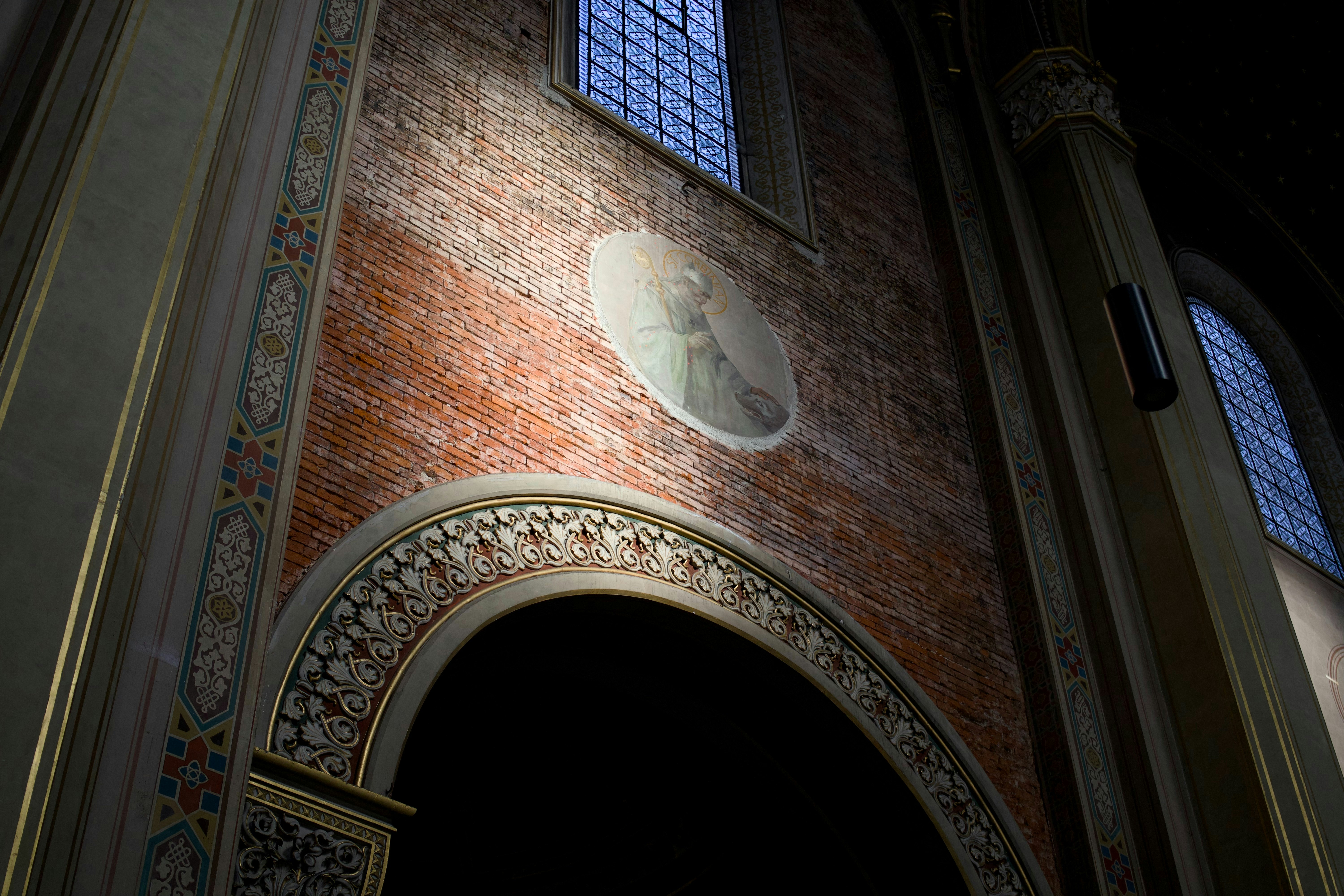 Bricked Archway Under a Faded Circular Fresco