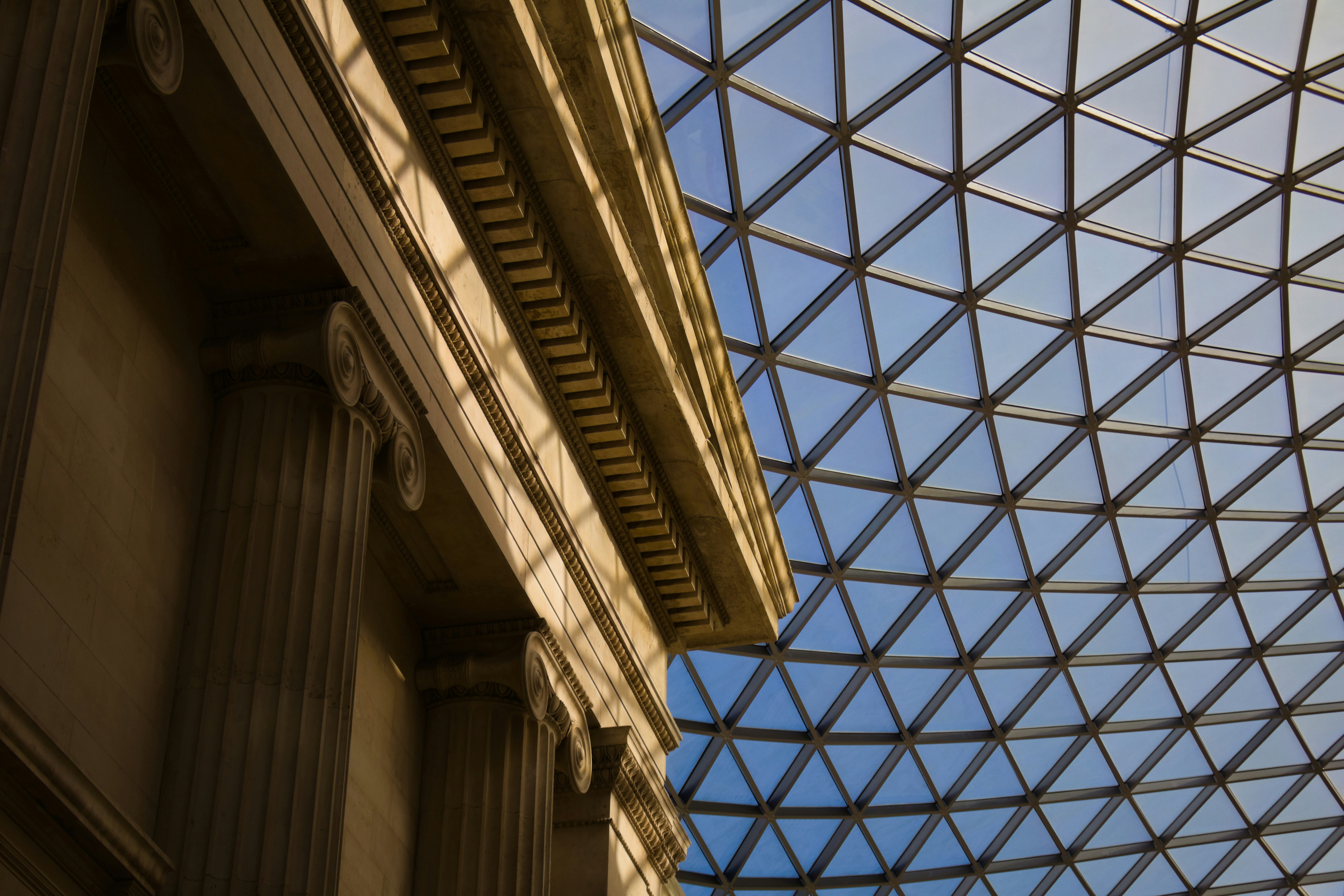 Geometric Glass Canopy Over Classical Columns