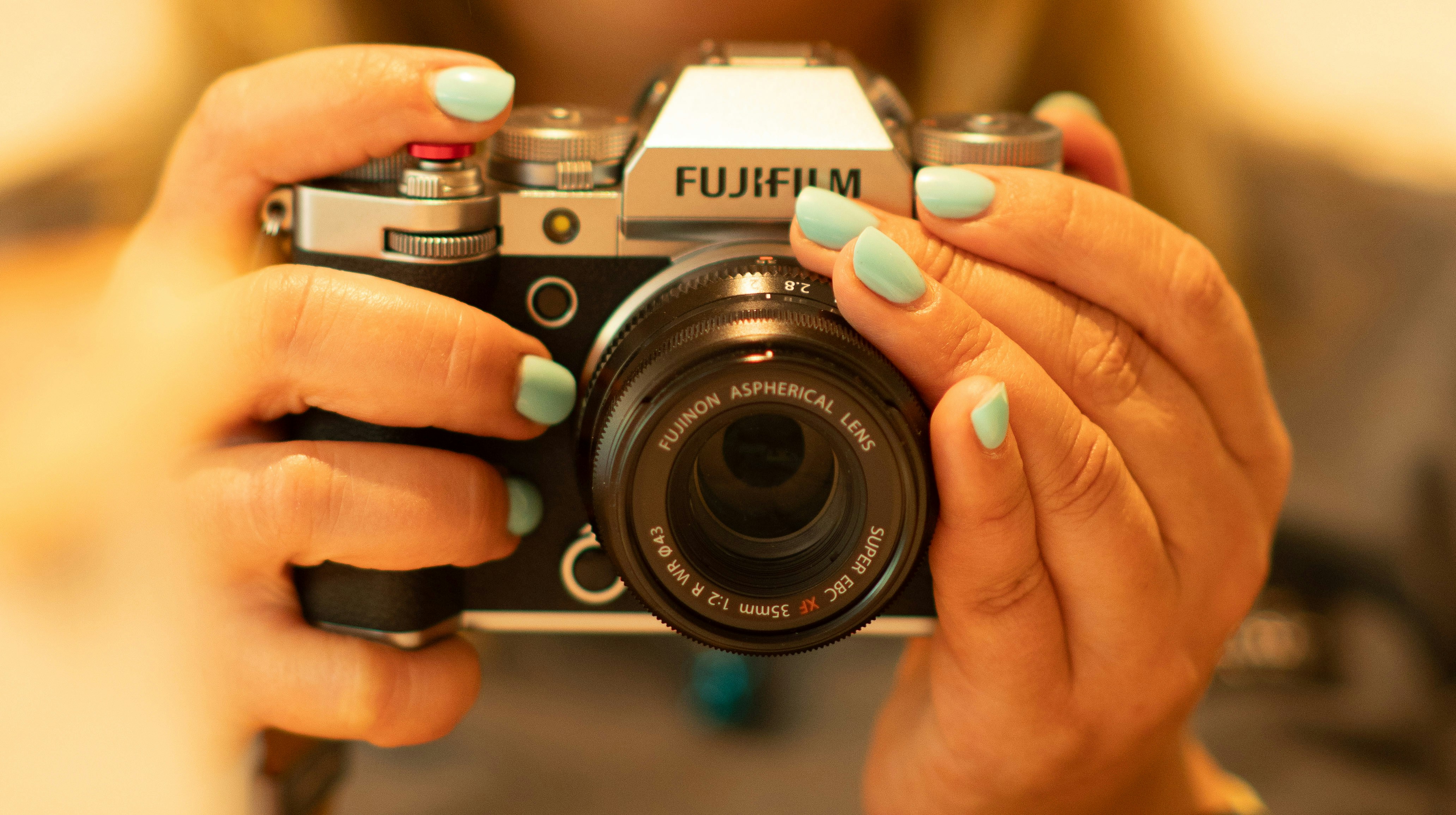 Centered in Focus: A Handful of Turquoise Nails Grasp a Classic Fujifilm