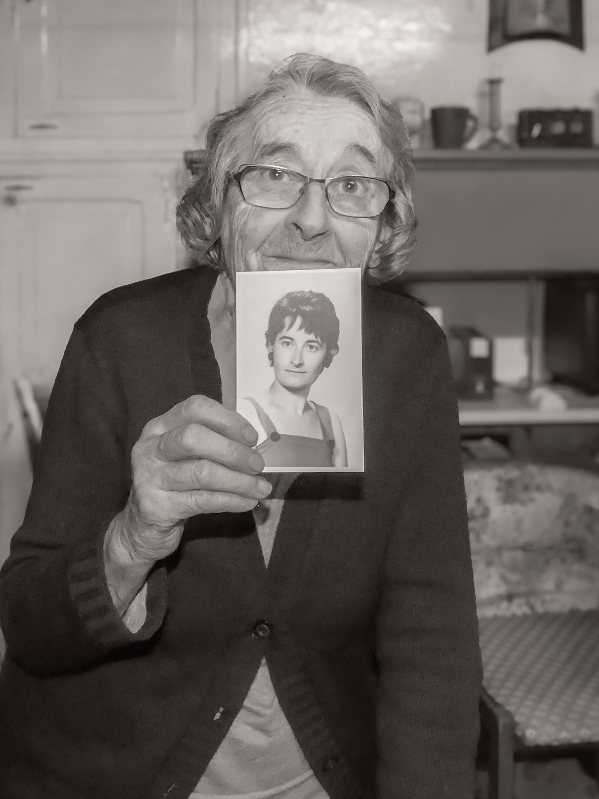 Holding a Lost Portrait: A grandmother with a photograph of her younger self