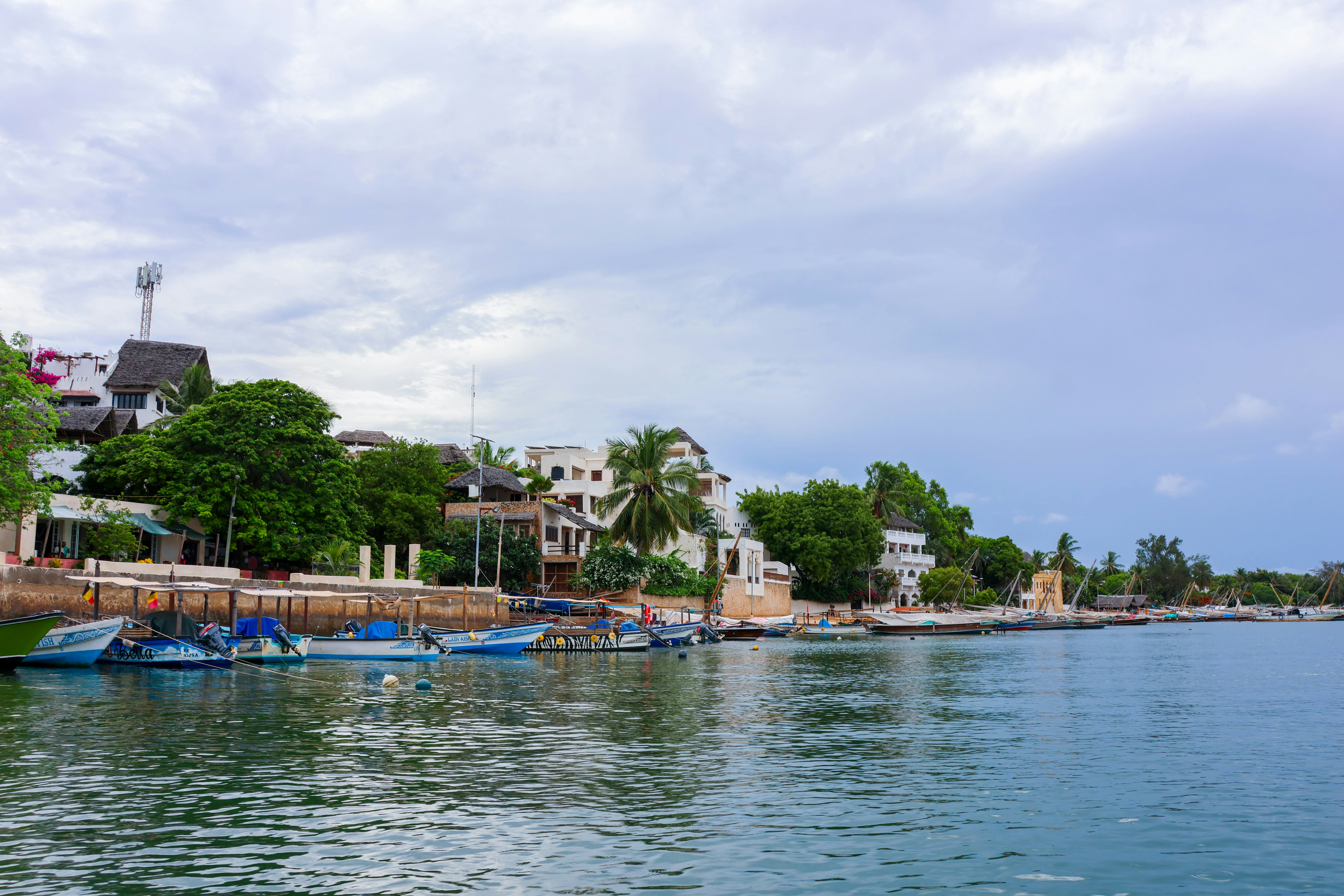 Quiet seaside village morning with boats along the quay