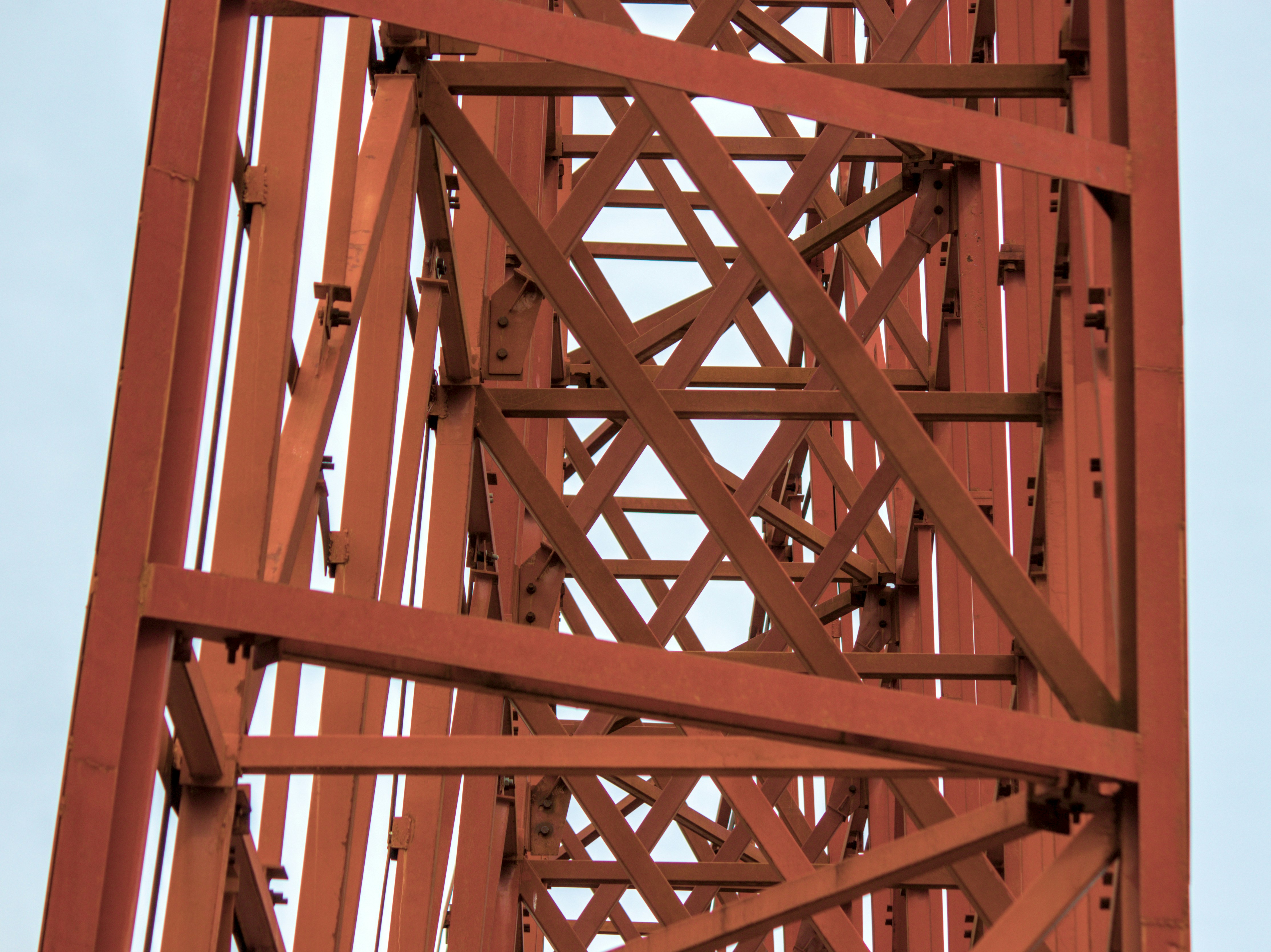 Crisscrossed Rails: An Abstract Red Steel Panorama
