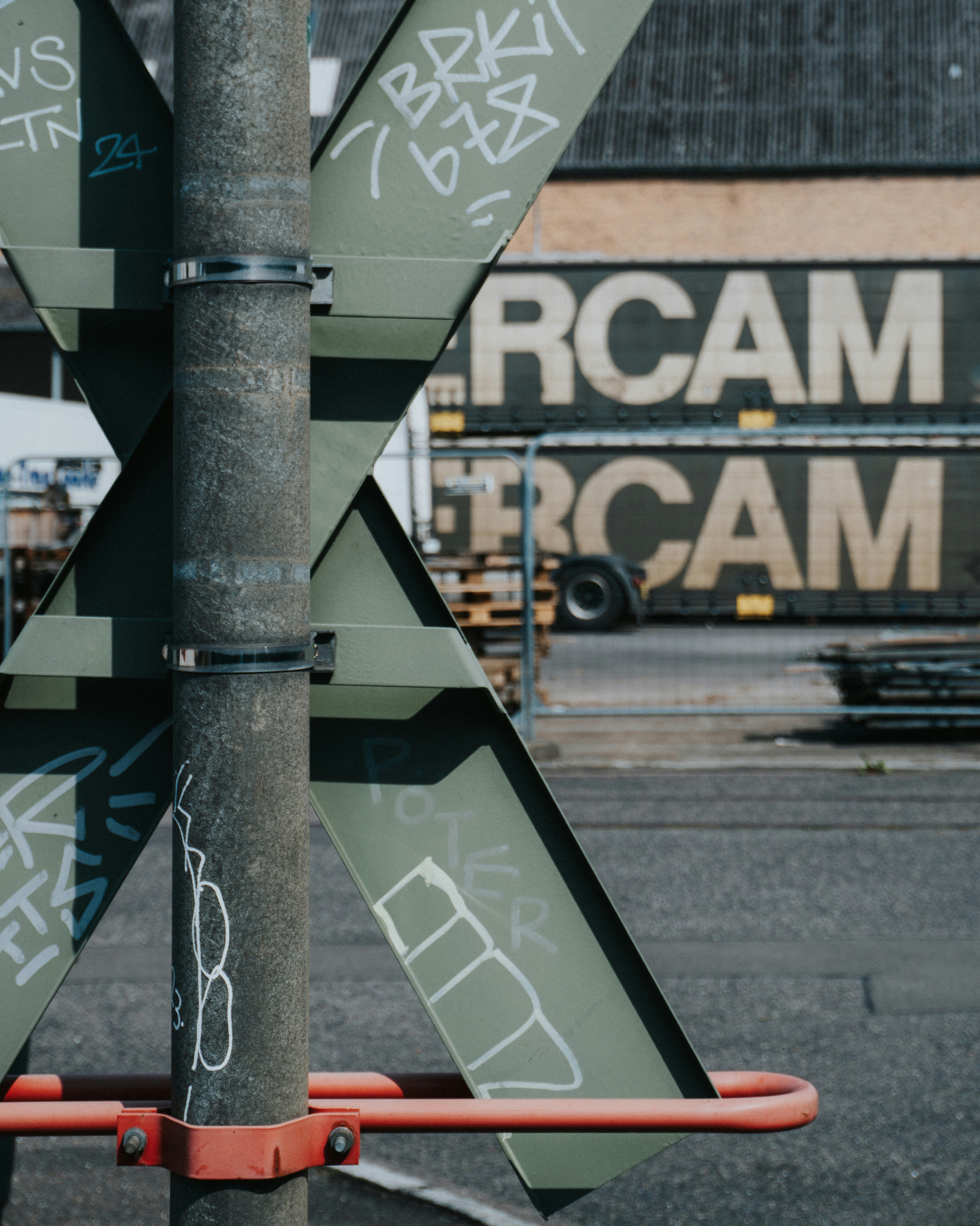 Graffitied Structure Framing a Distant Build‑Out