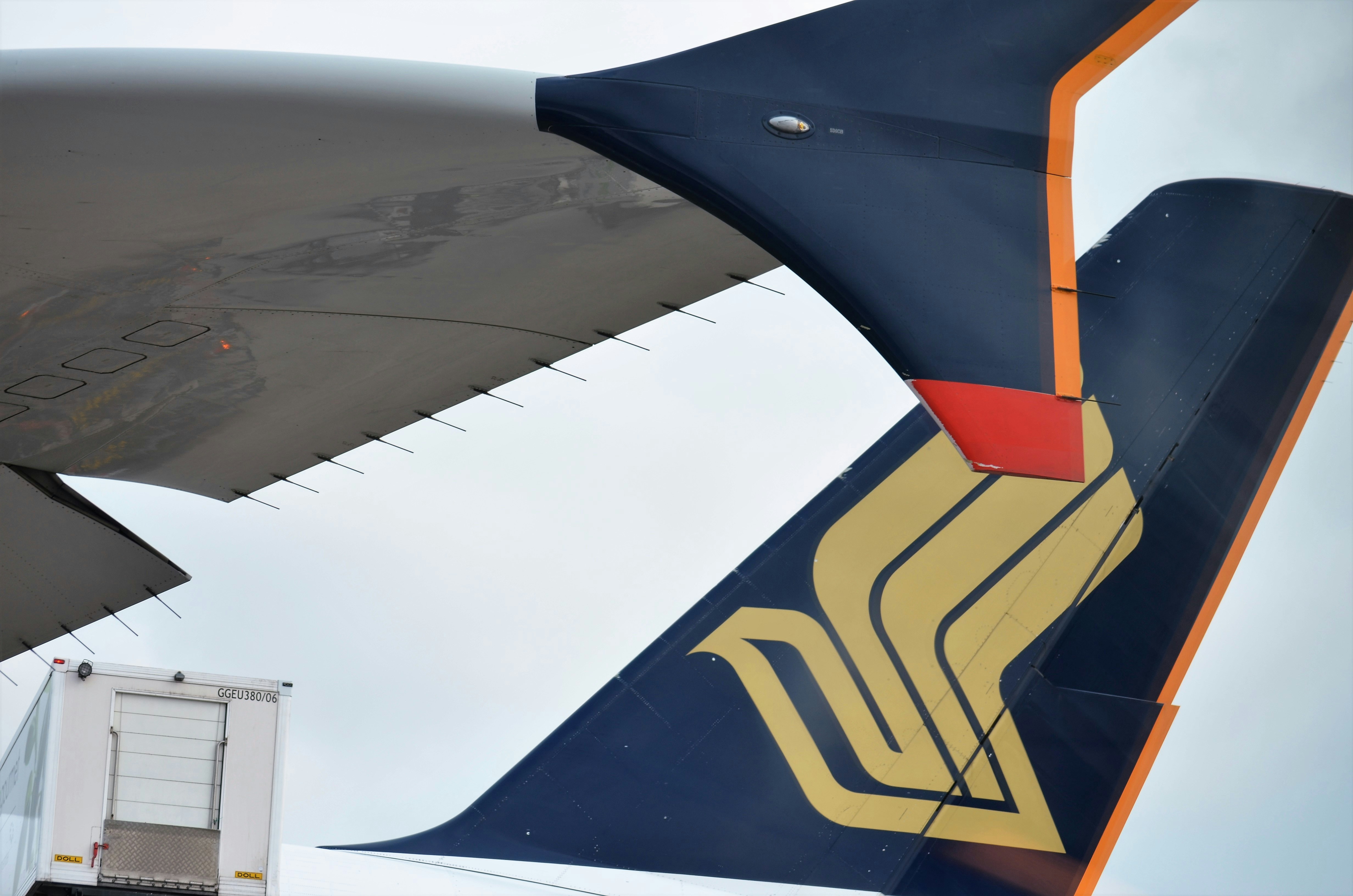 Tailfin Geometry: A Jetway Backdrop with Bold Orange Accents